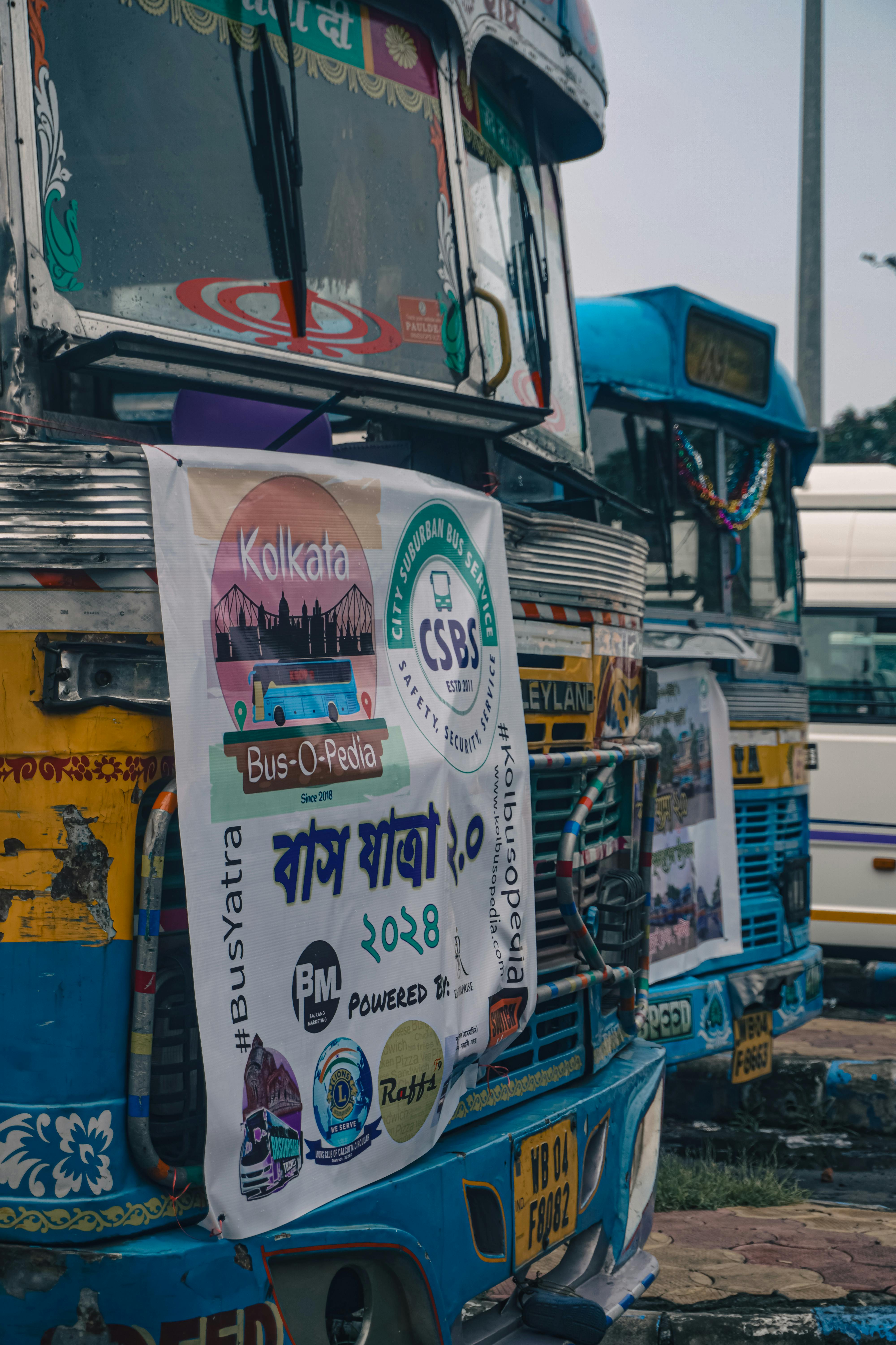 A bus with a banner on it in india · Free Stock Photo