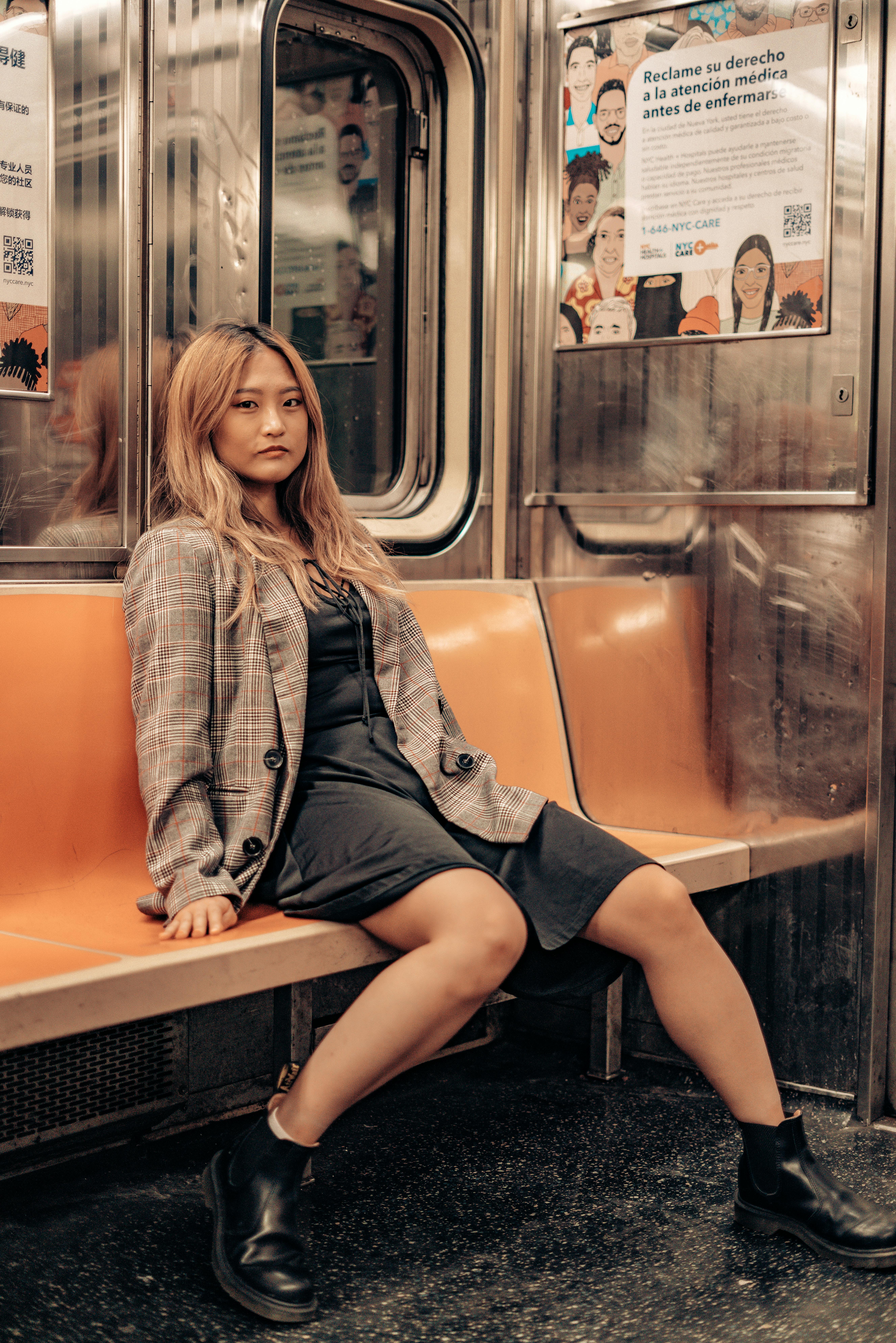 A woman sitting on a subway train · Free Stock Photo