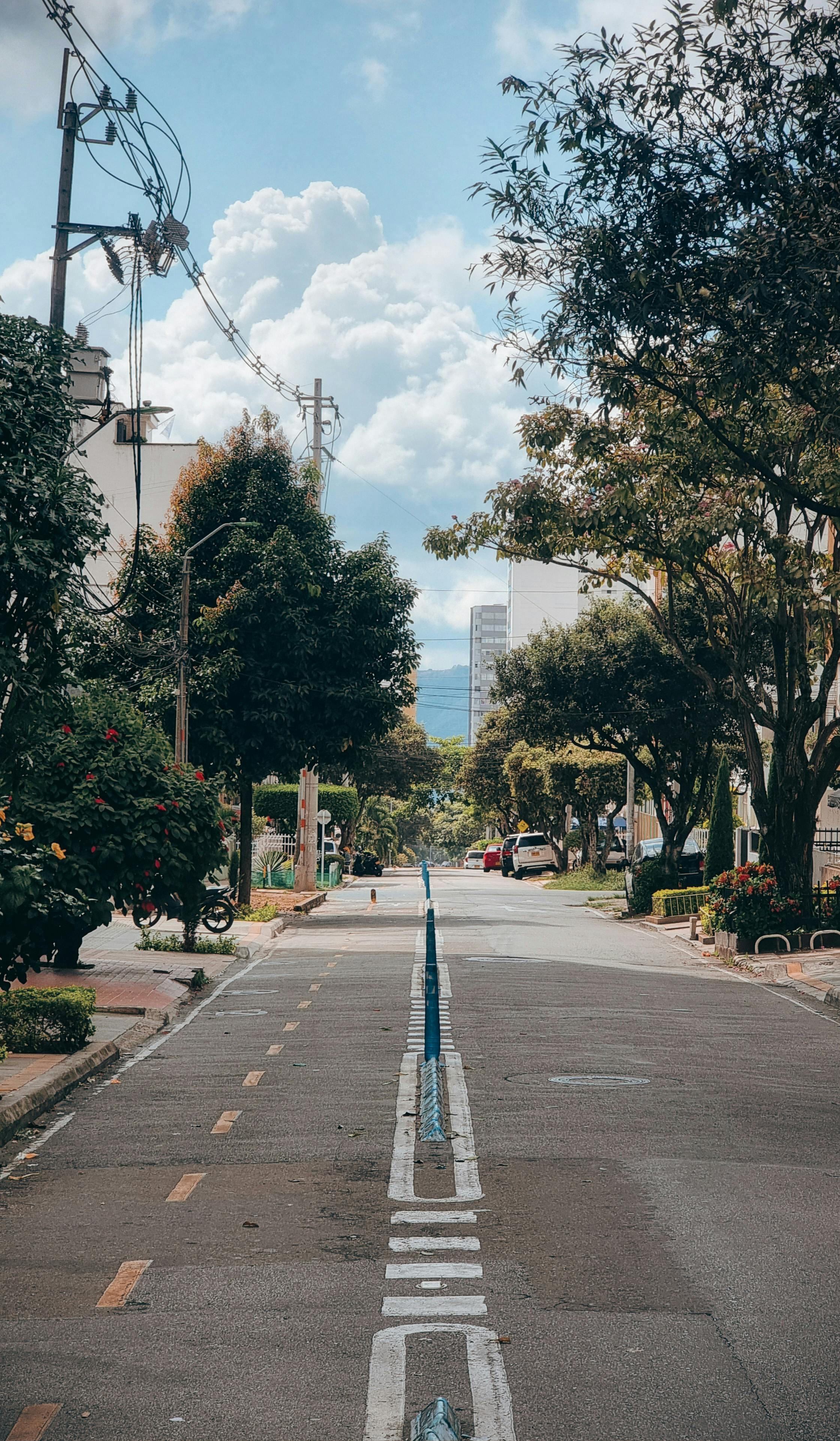 A street with a bike lane and a street sign · Free Stock Photo