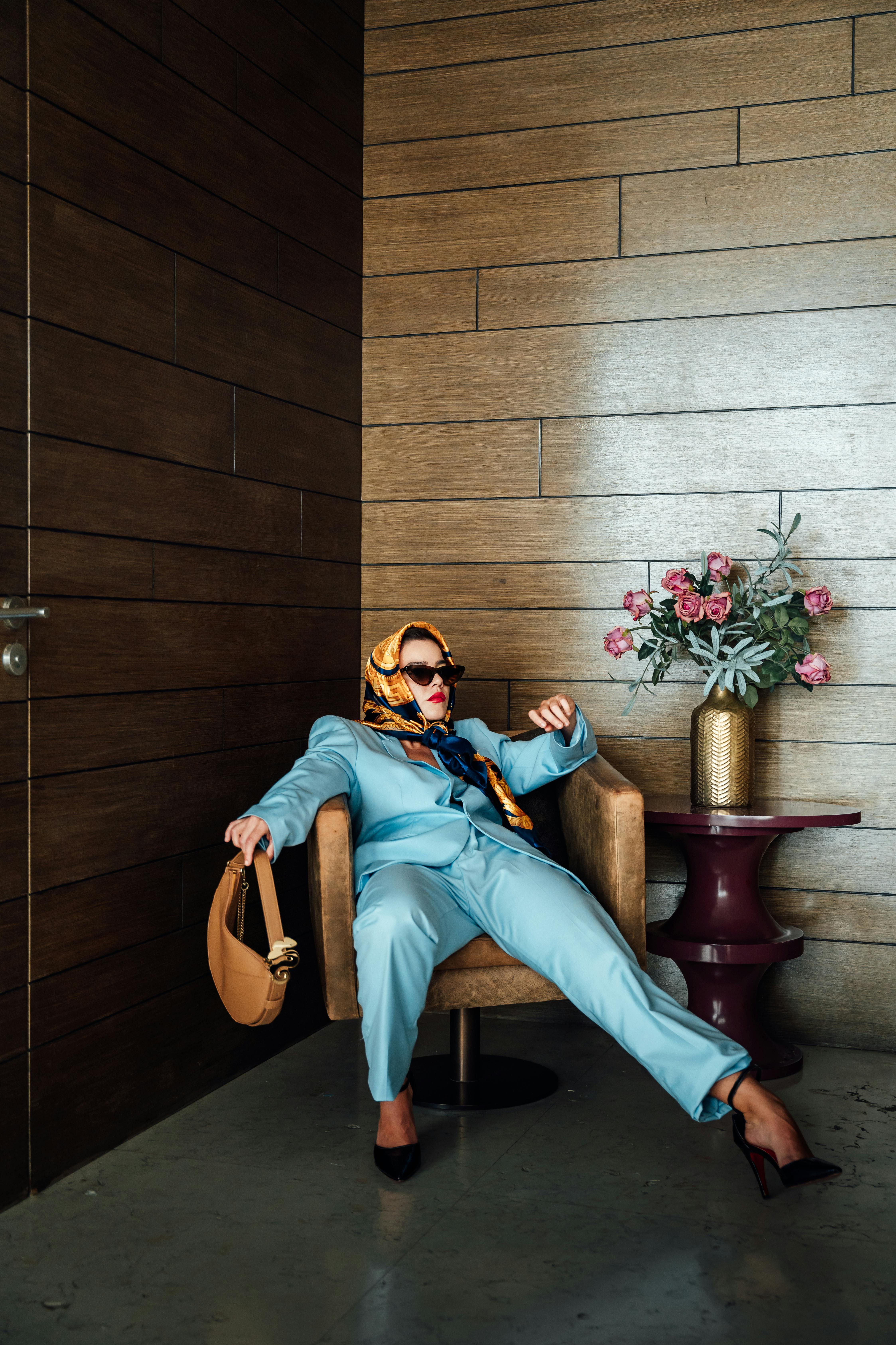 Woman in Blue Suit Jacket Lying Down on Armchair · Free Stock Photo