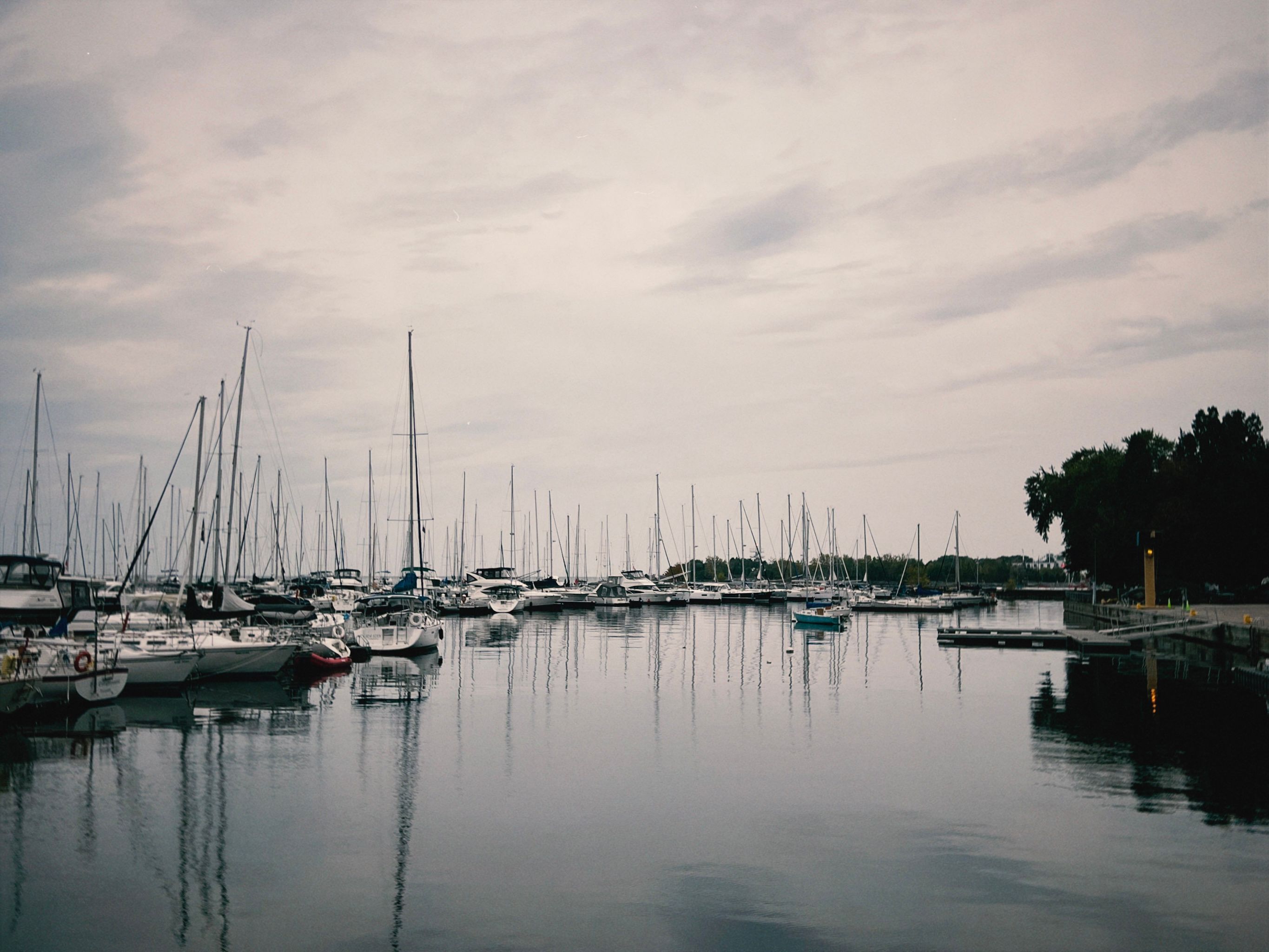 A marina with many boats docked in the water · Free Stock Photo