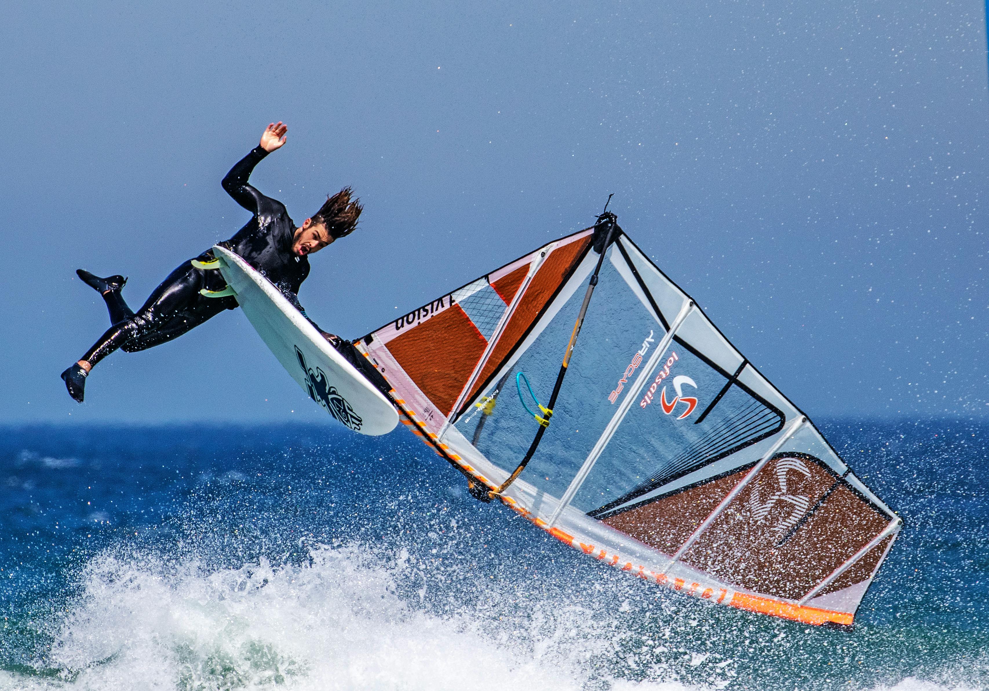 Person Riding Surf Board · Free Stock Photo