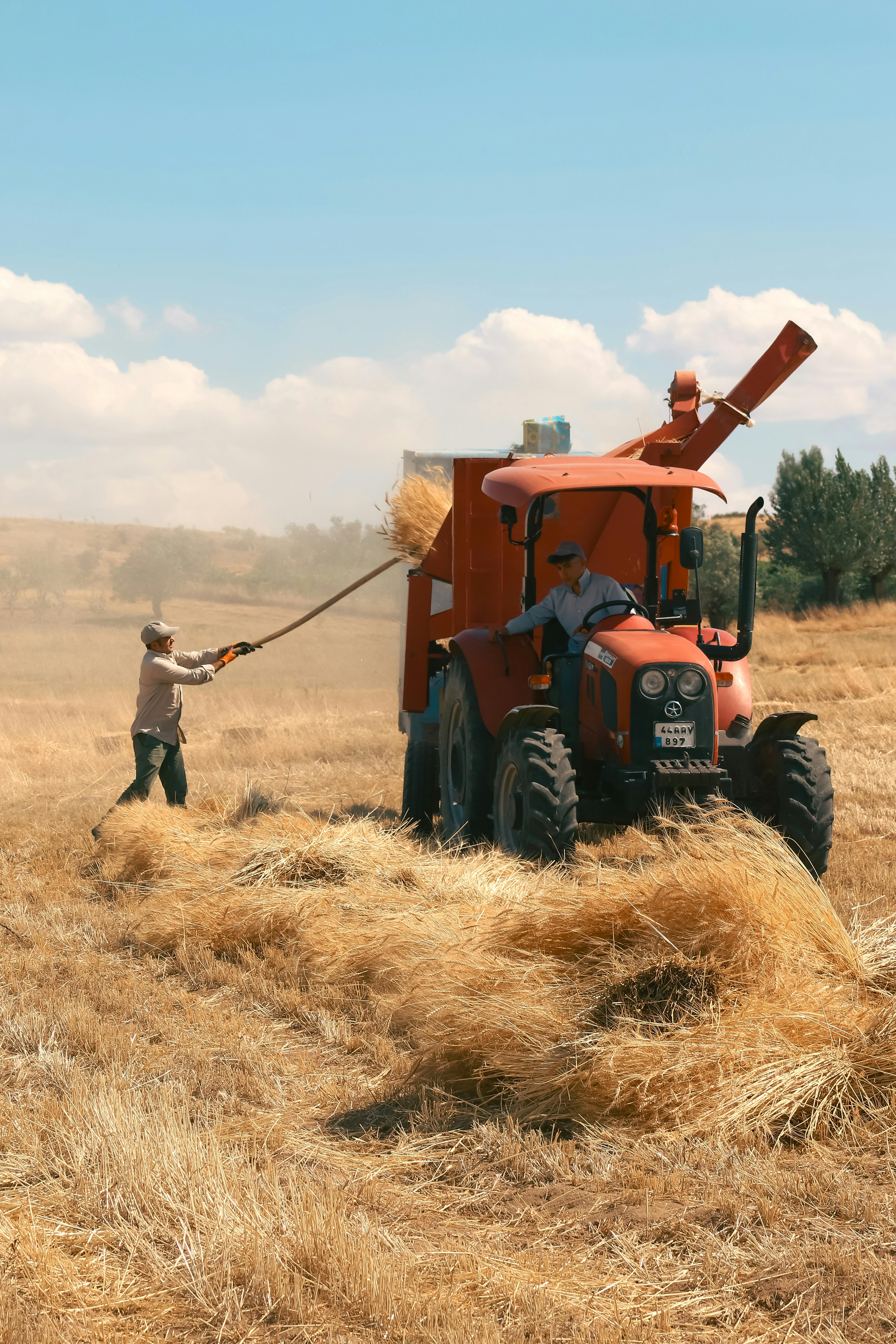 Farmers with Tractor in Field · Free Stock Photo