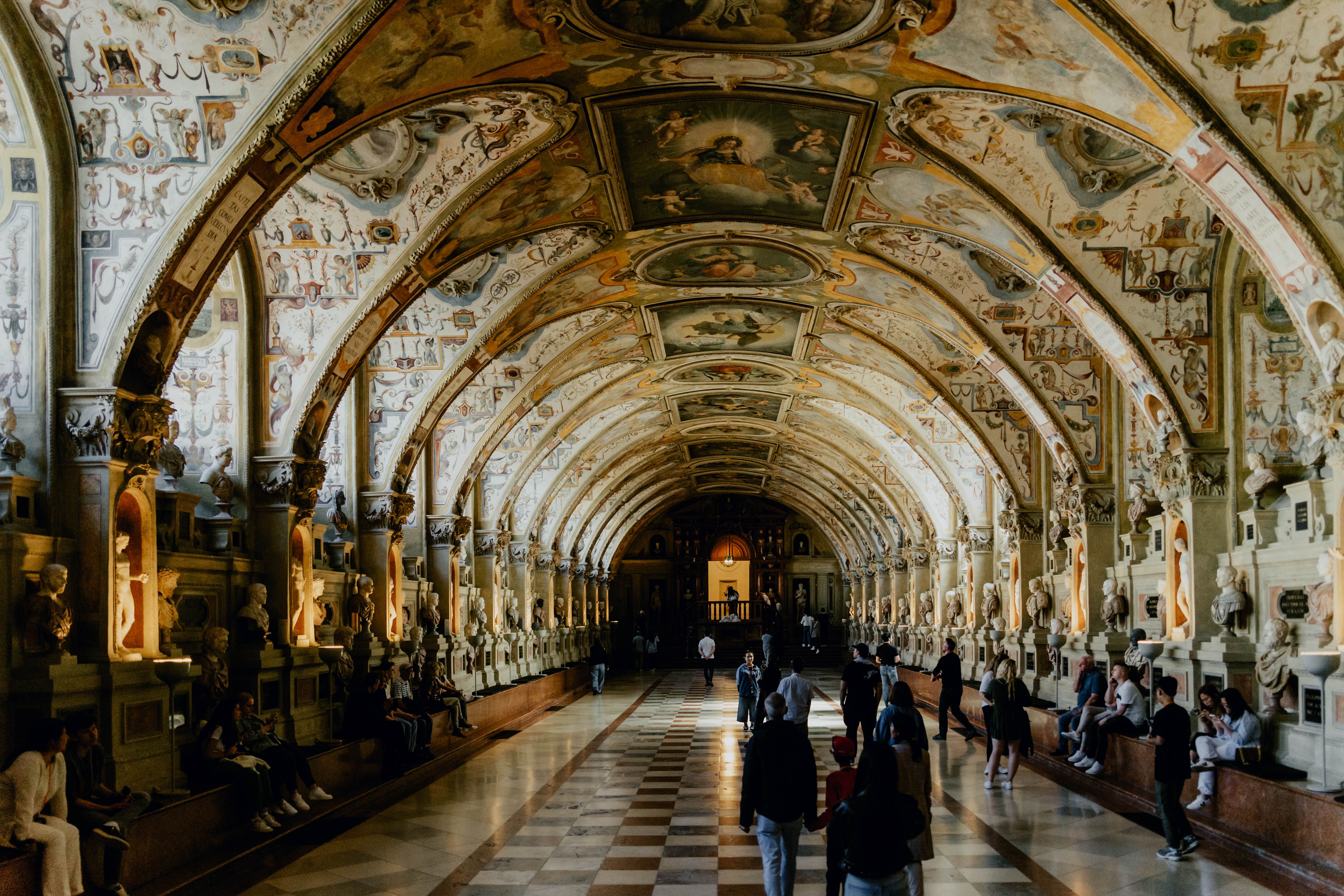 The inside of a large building with many people walking · Free Stock Photo