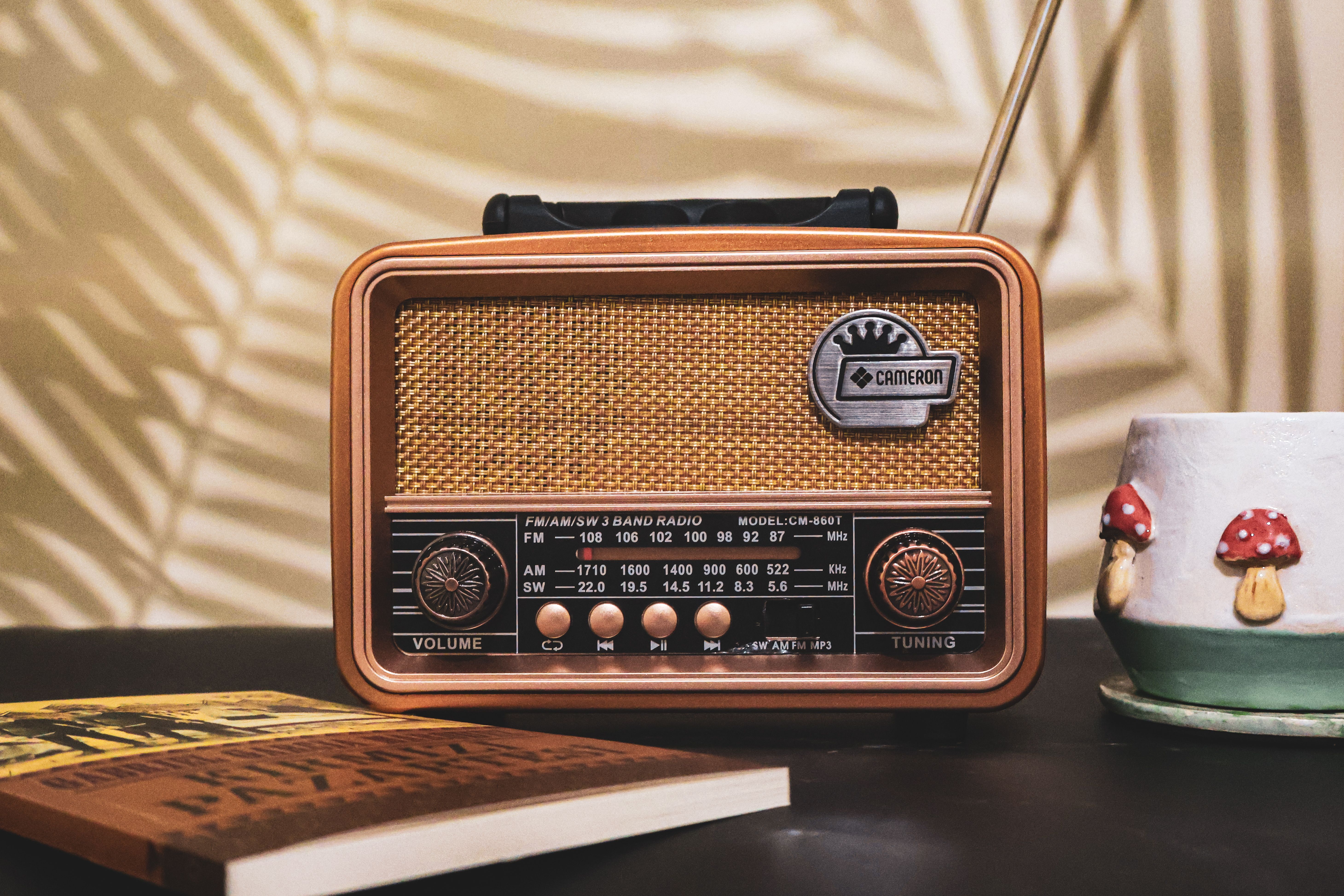 A radio with a cup of coffee on a table · Free Stock Photo