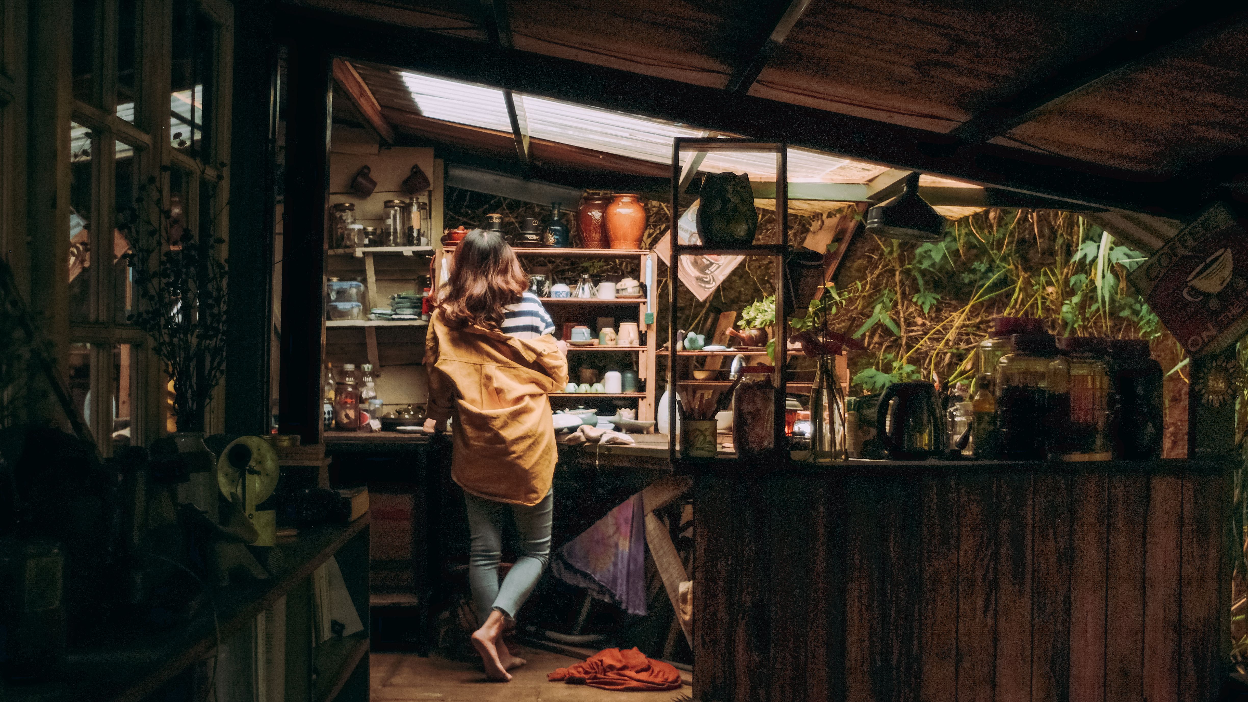 Woman Standing Beside Shelf · Free Stock Photo