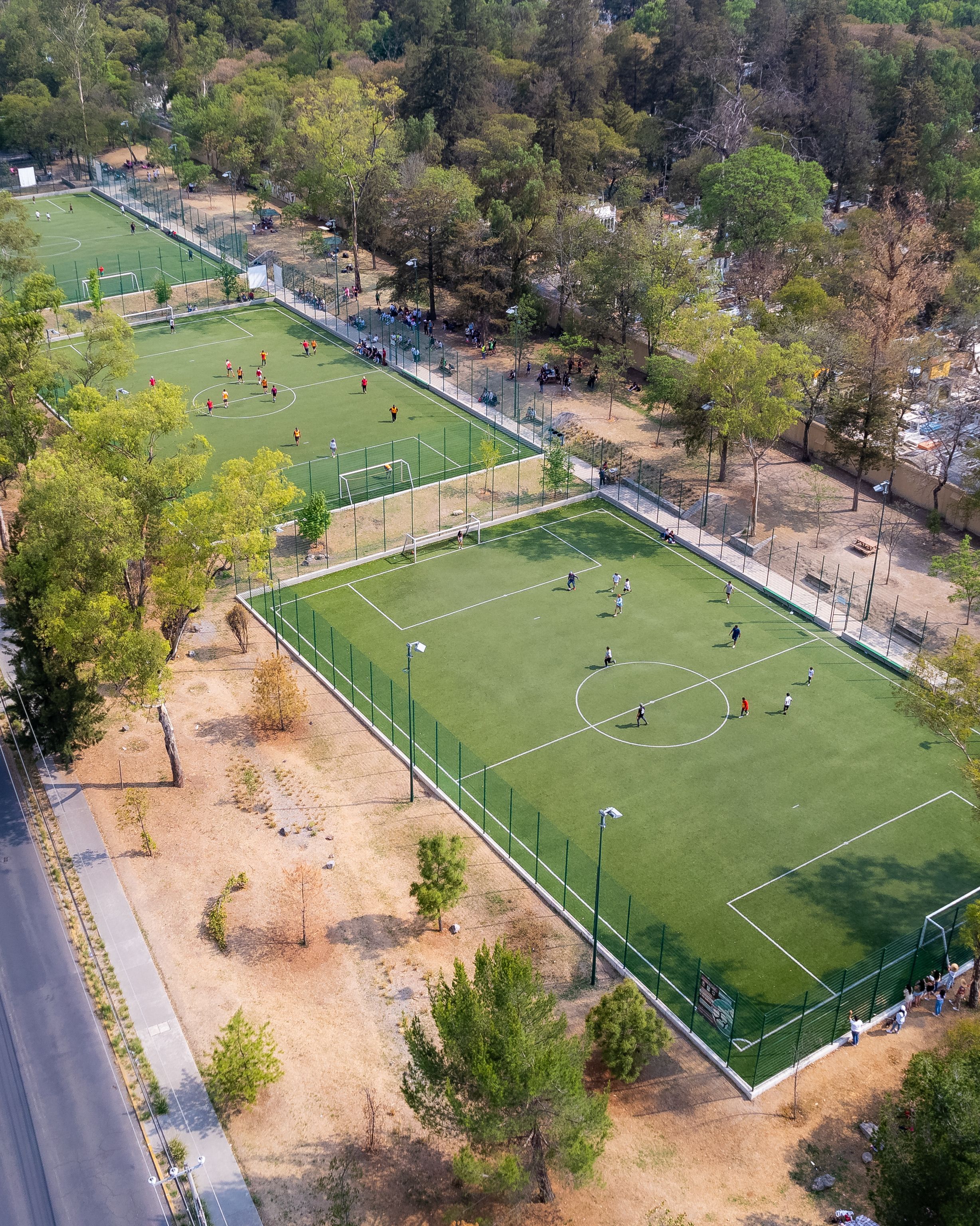 An aerial view of a soccer field with trees and people · Free Stock Photo