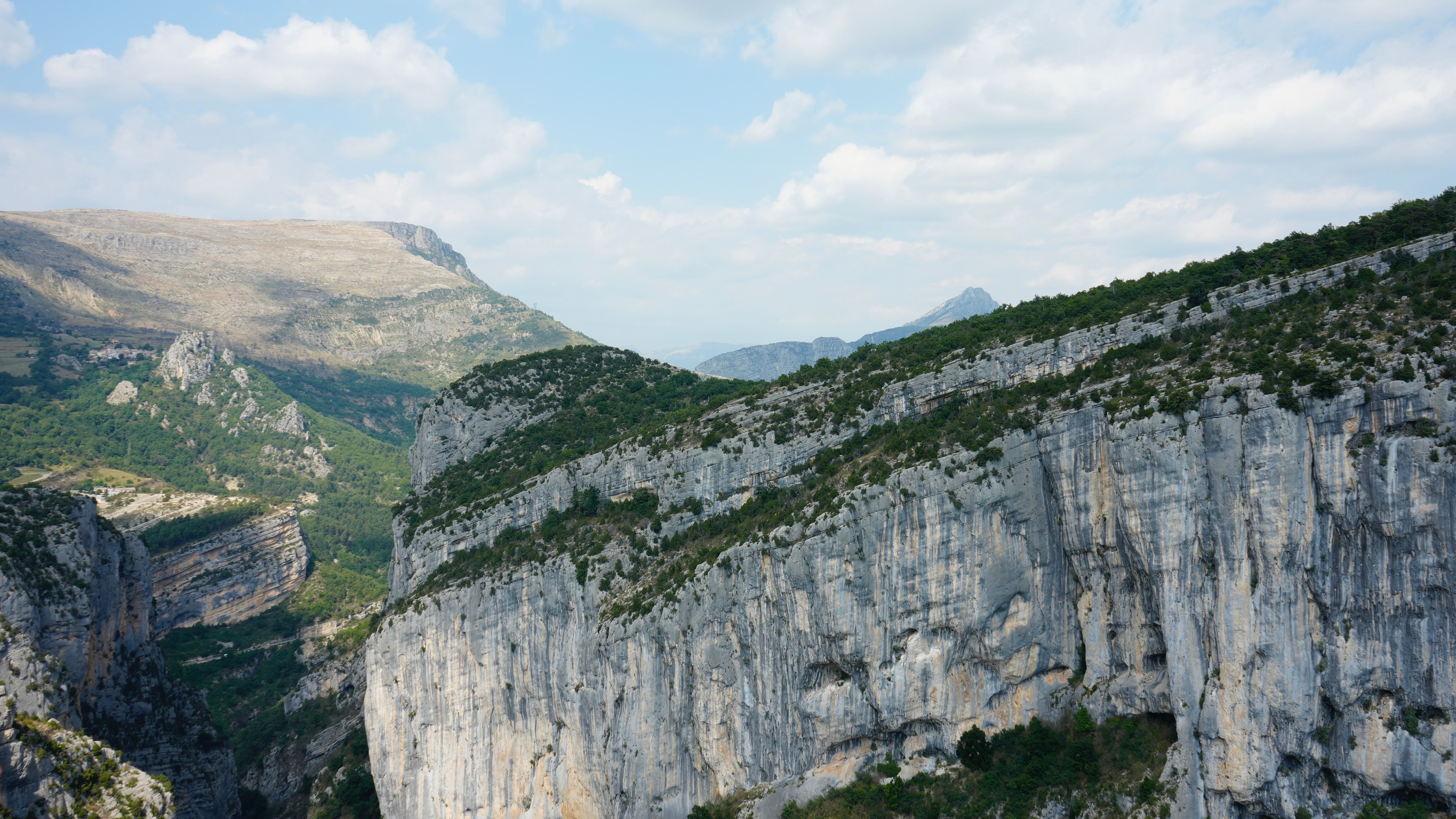 A view of a cliff with a valley below · Free Stock Photo