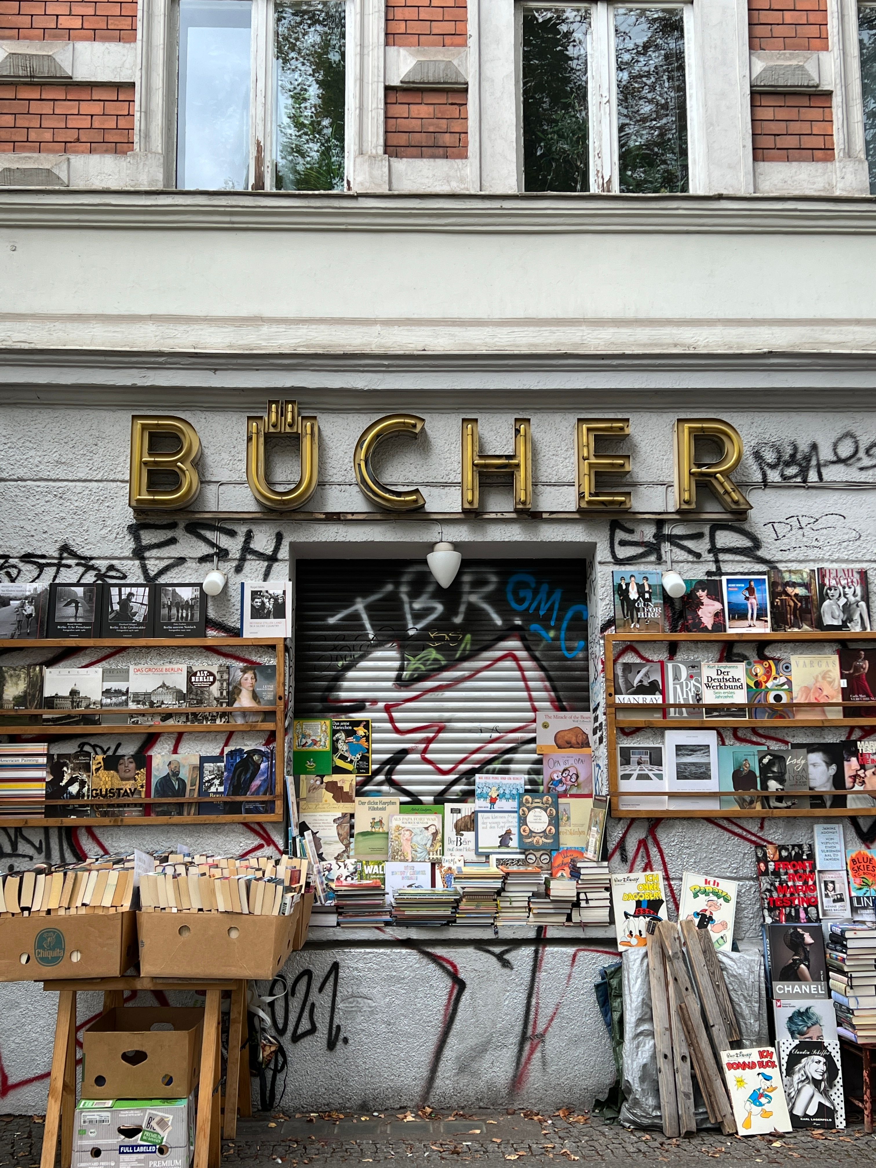 A store front with books and magazines on the wall · Free Stock Photo