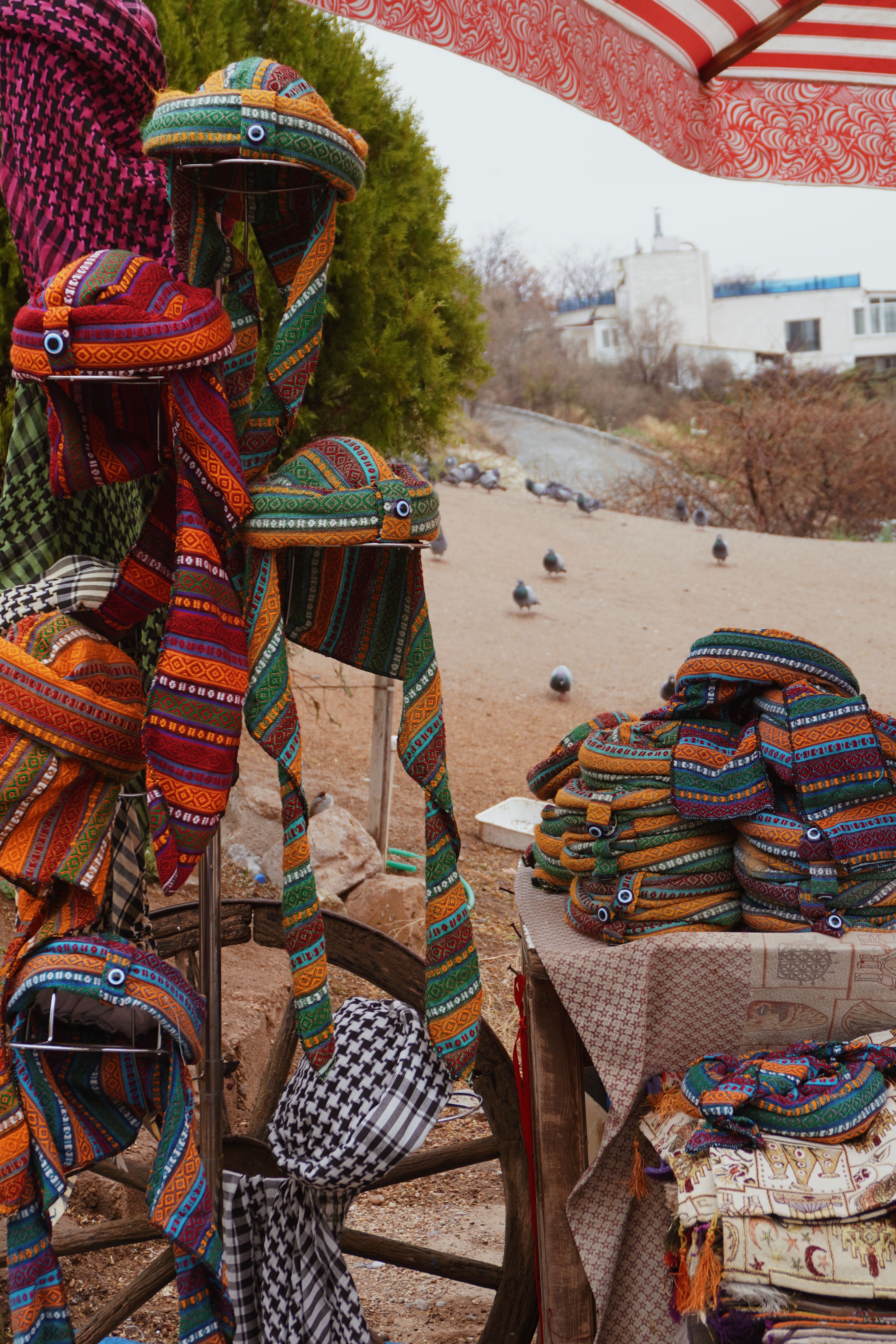 A colorful hat is on display at a market · Free Stock Photo