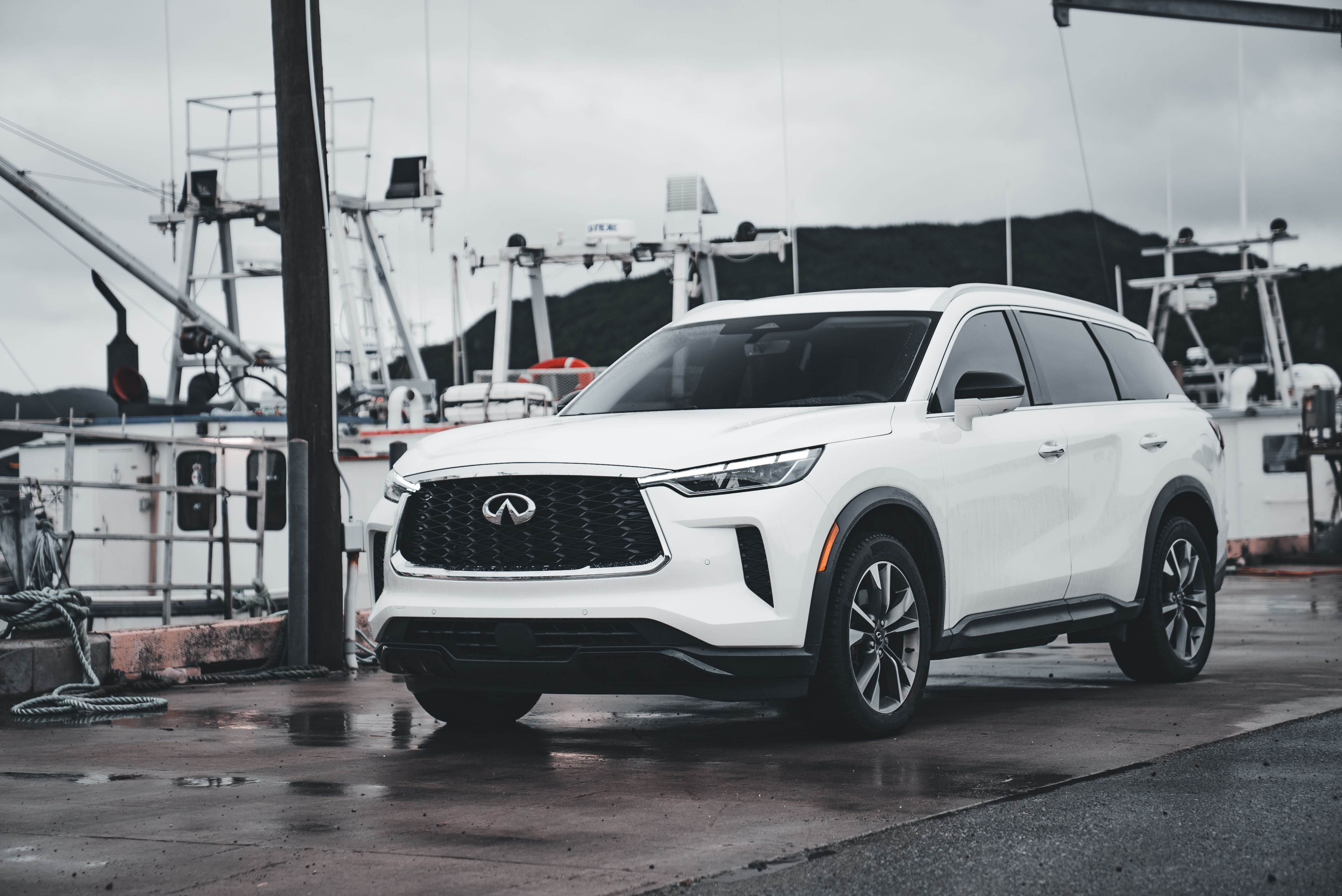 The infiniti suv parked in front of a dock · Free Stock Photo