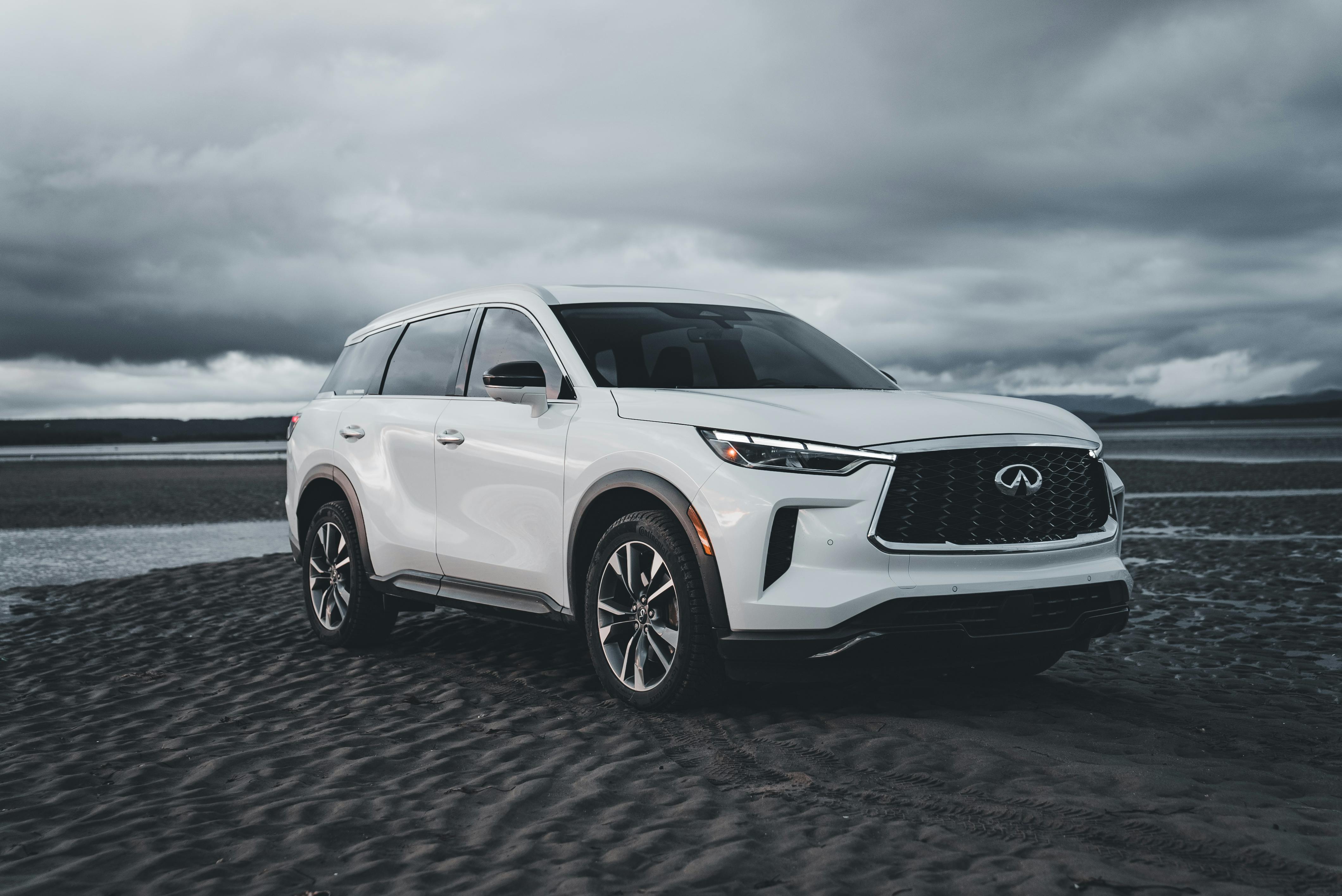 The 2020 infiniti suv is parked on a beach · Free Stock Photo