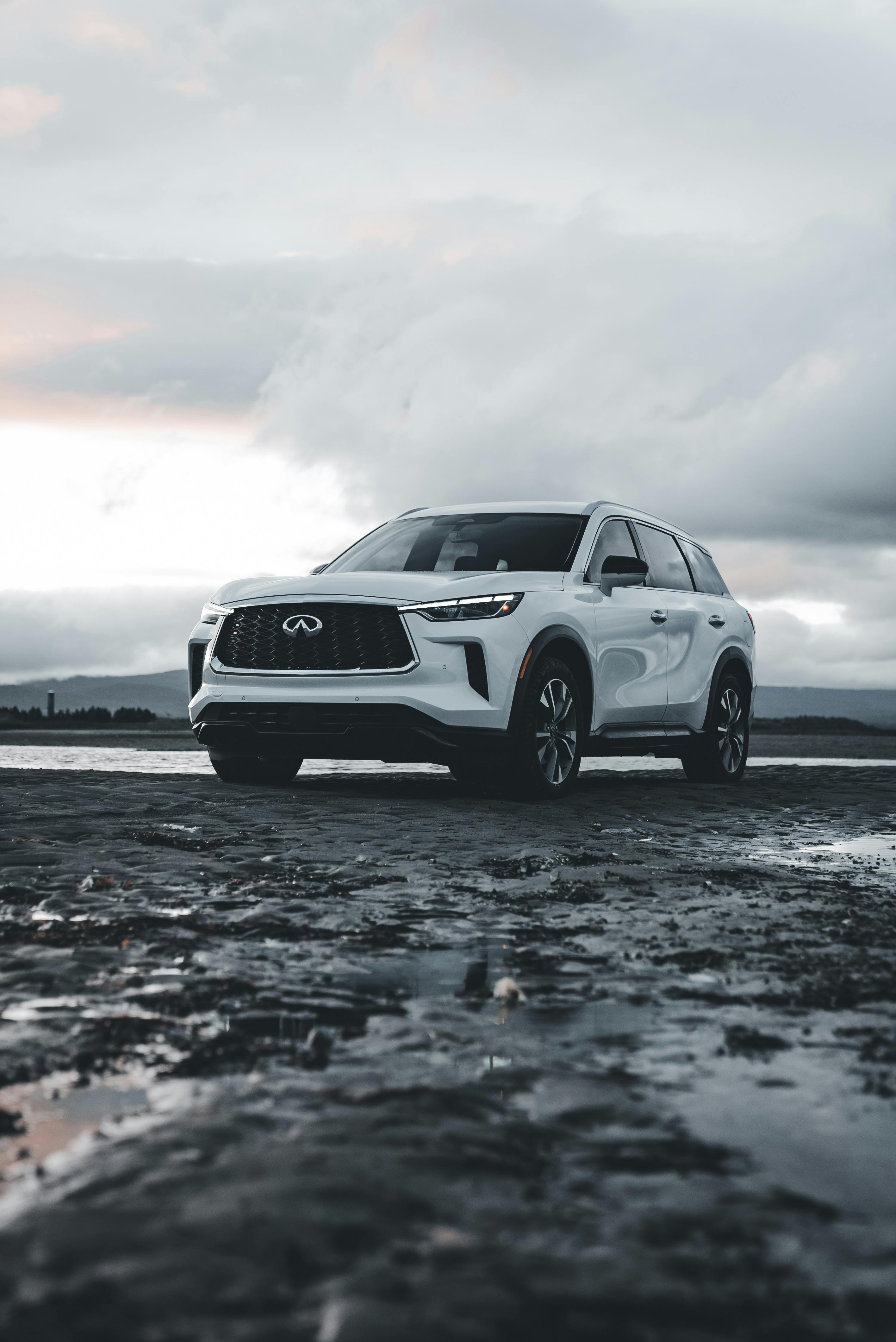 The 2020 infiniti suv parked on a beach · Free Stock Photo