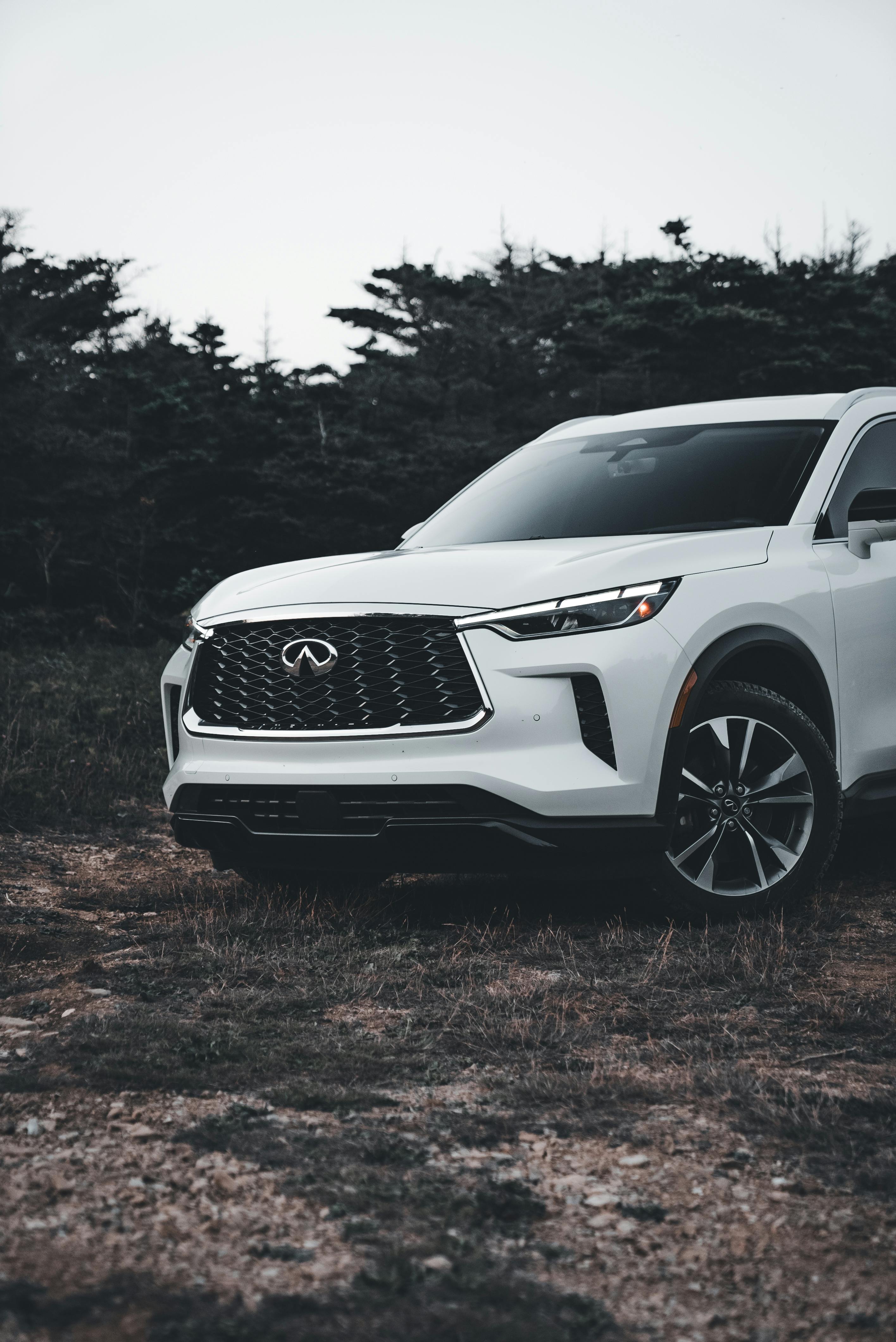 The front end of a white infiniti suv · Free Stock Photo