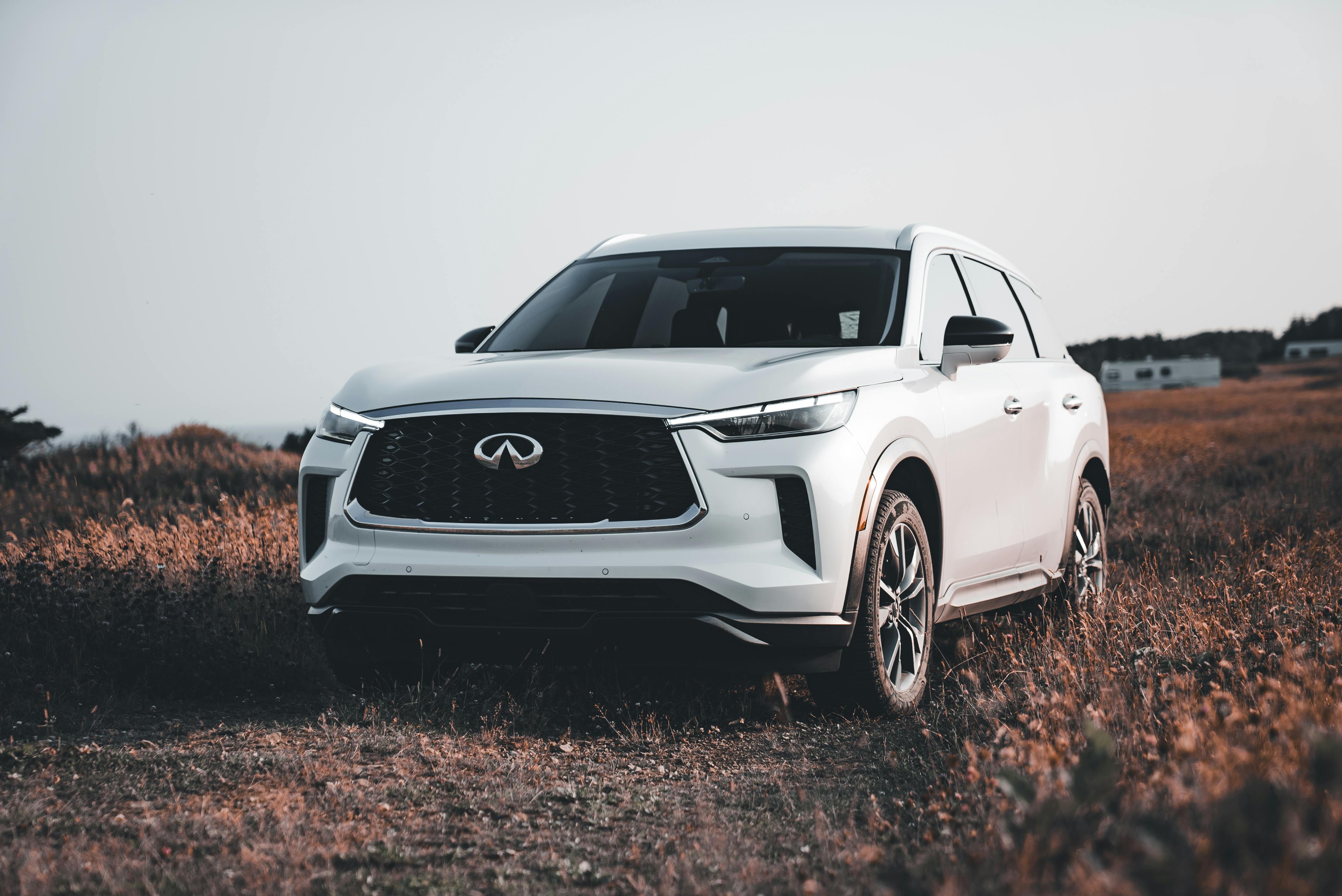 The 2020 infiniti suv is parked on a beach · Free Stock Photo