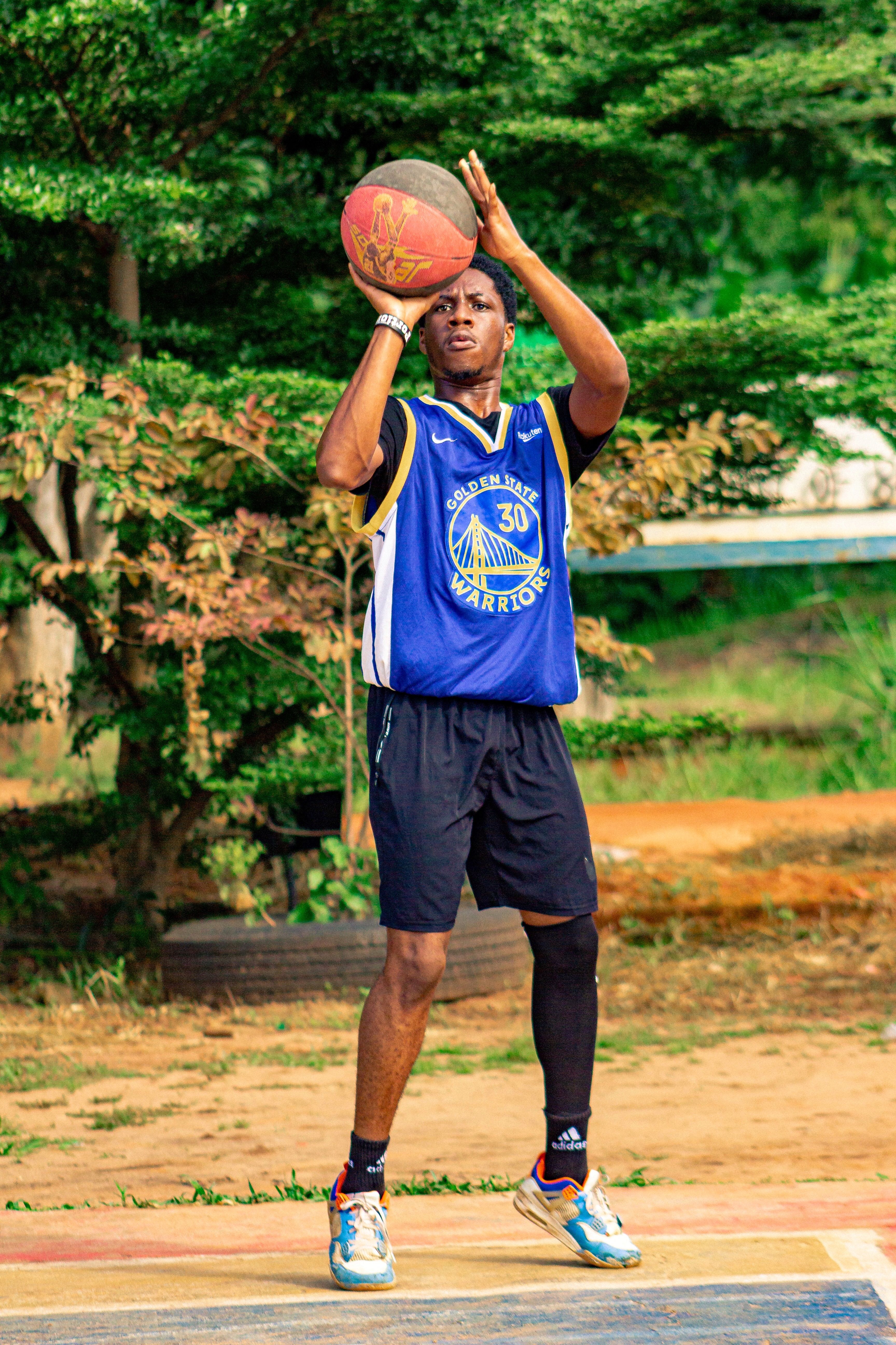 A young man in blue and black basketball uniform · Free Stock Photo