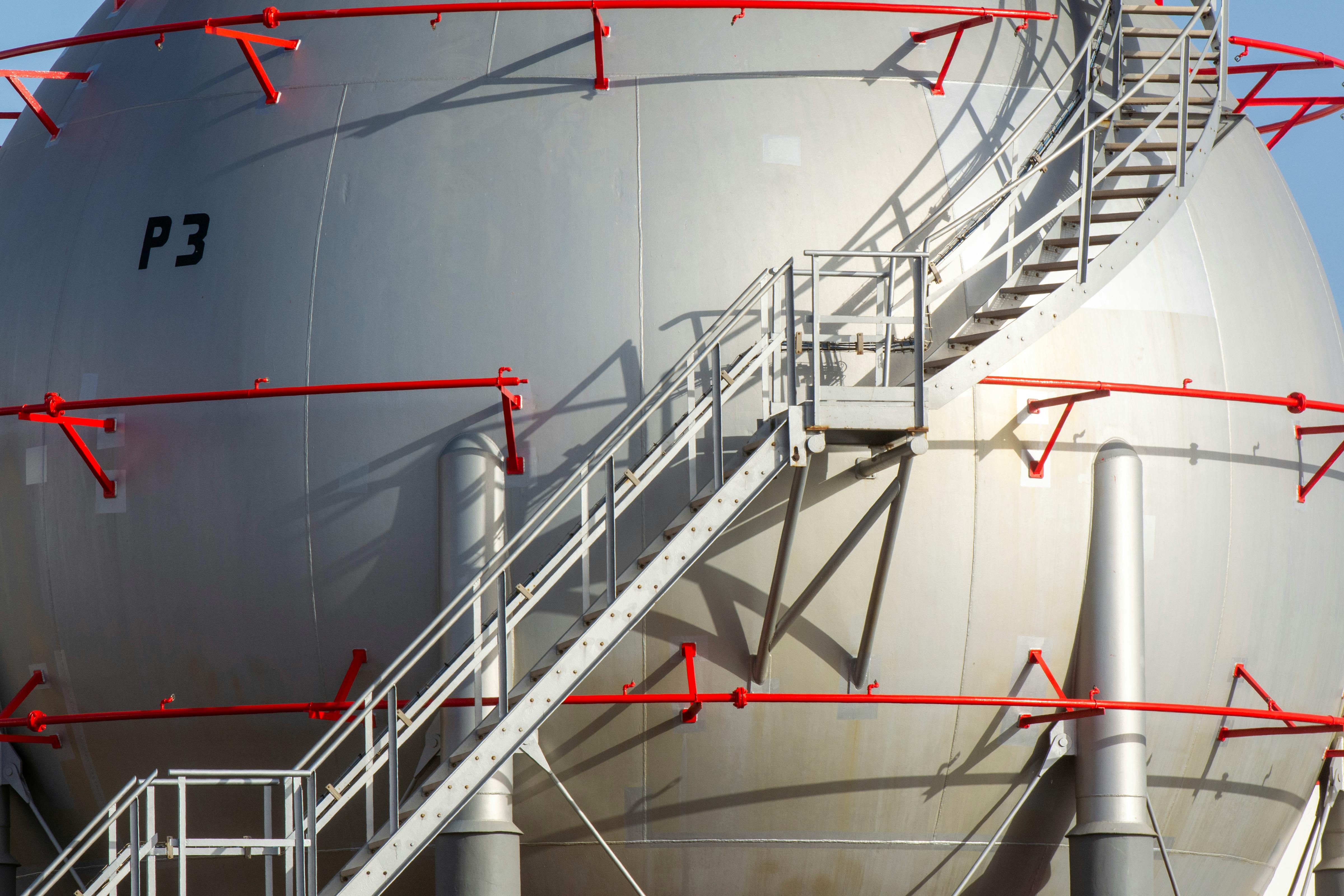 A large steel tank with stairs and a ladder · Free Stock Photo