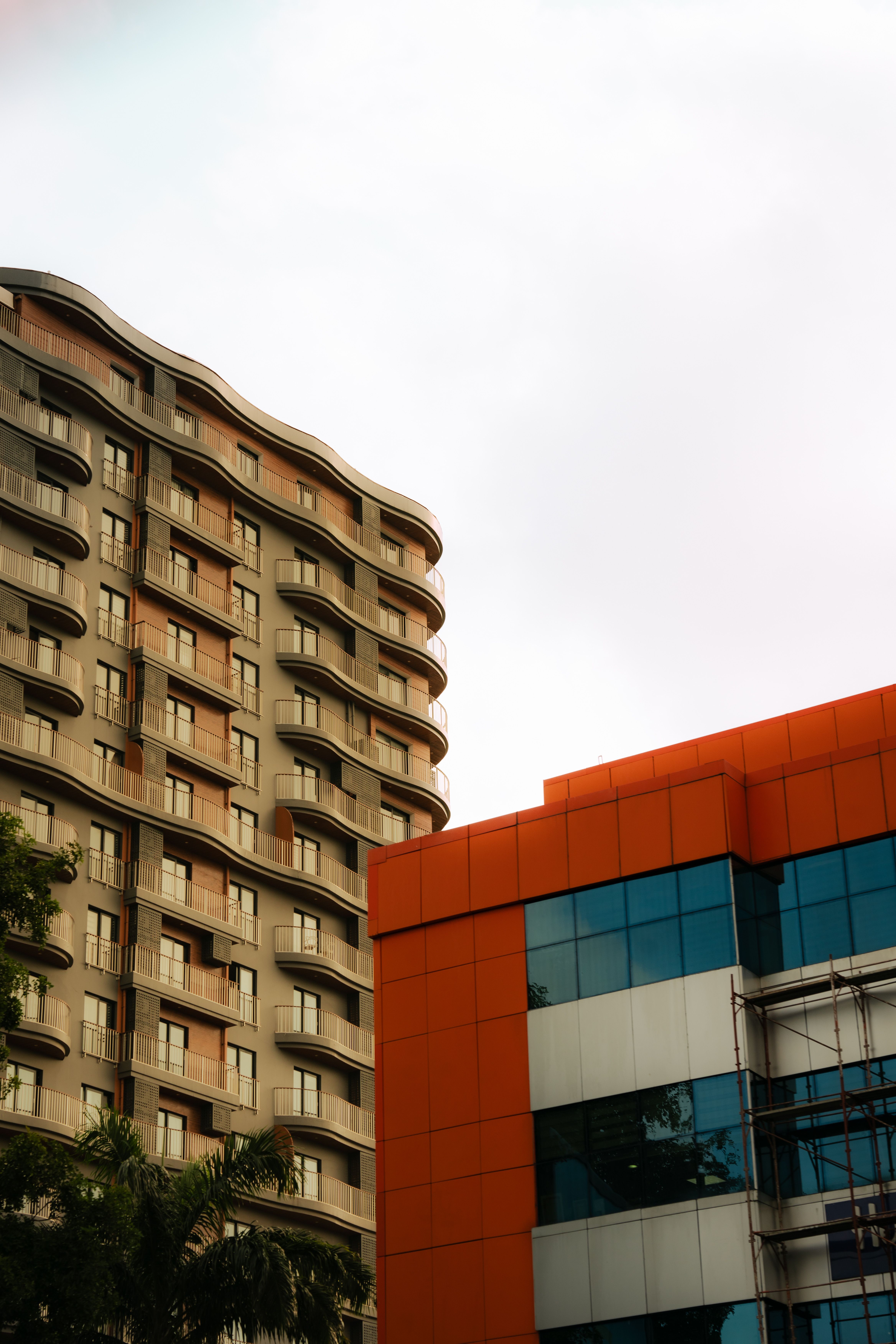 A tall building with orange and white windows · Free Stock Photo