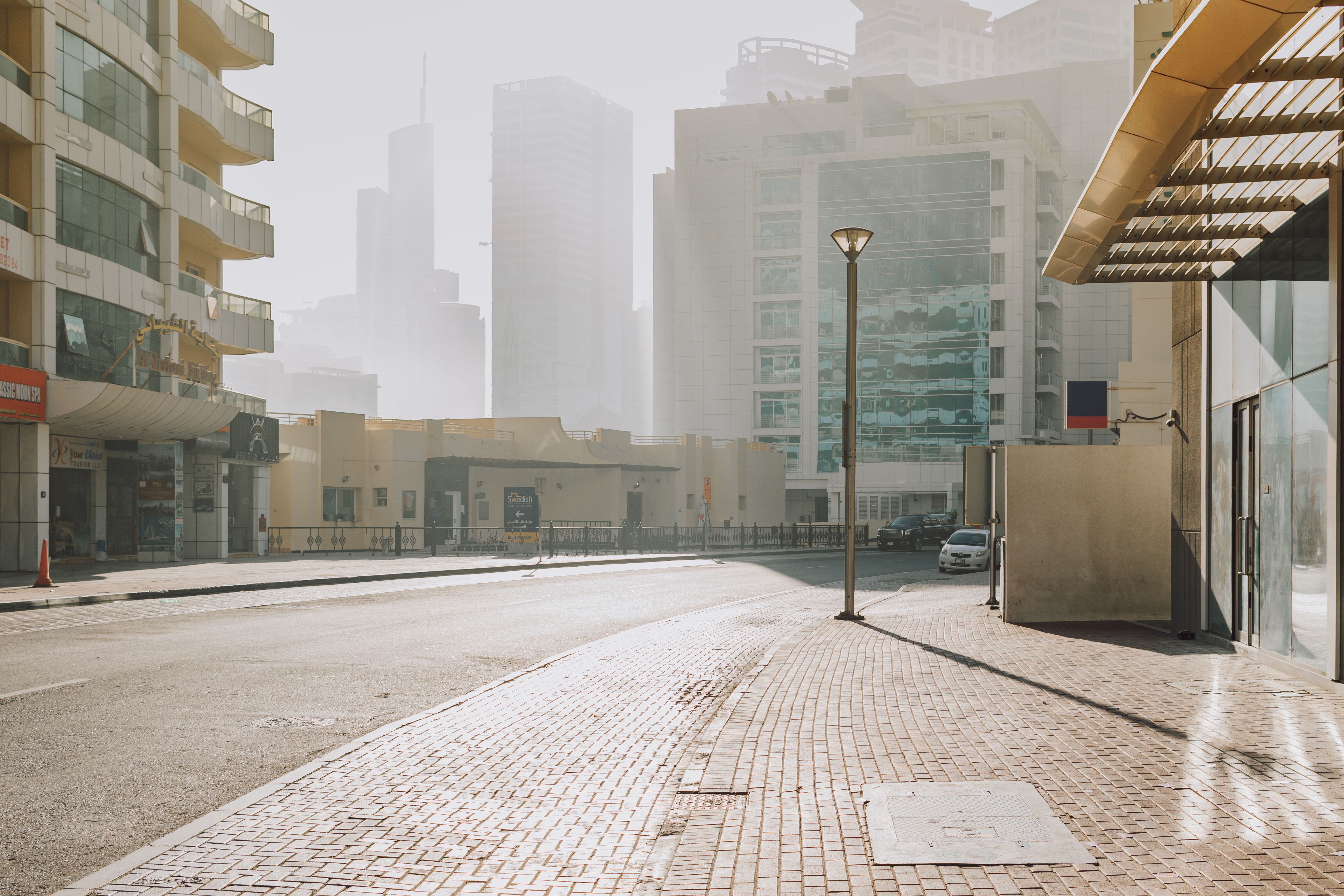 Curved street sidewalk with modern buildings, hotels and sun ...