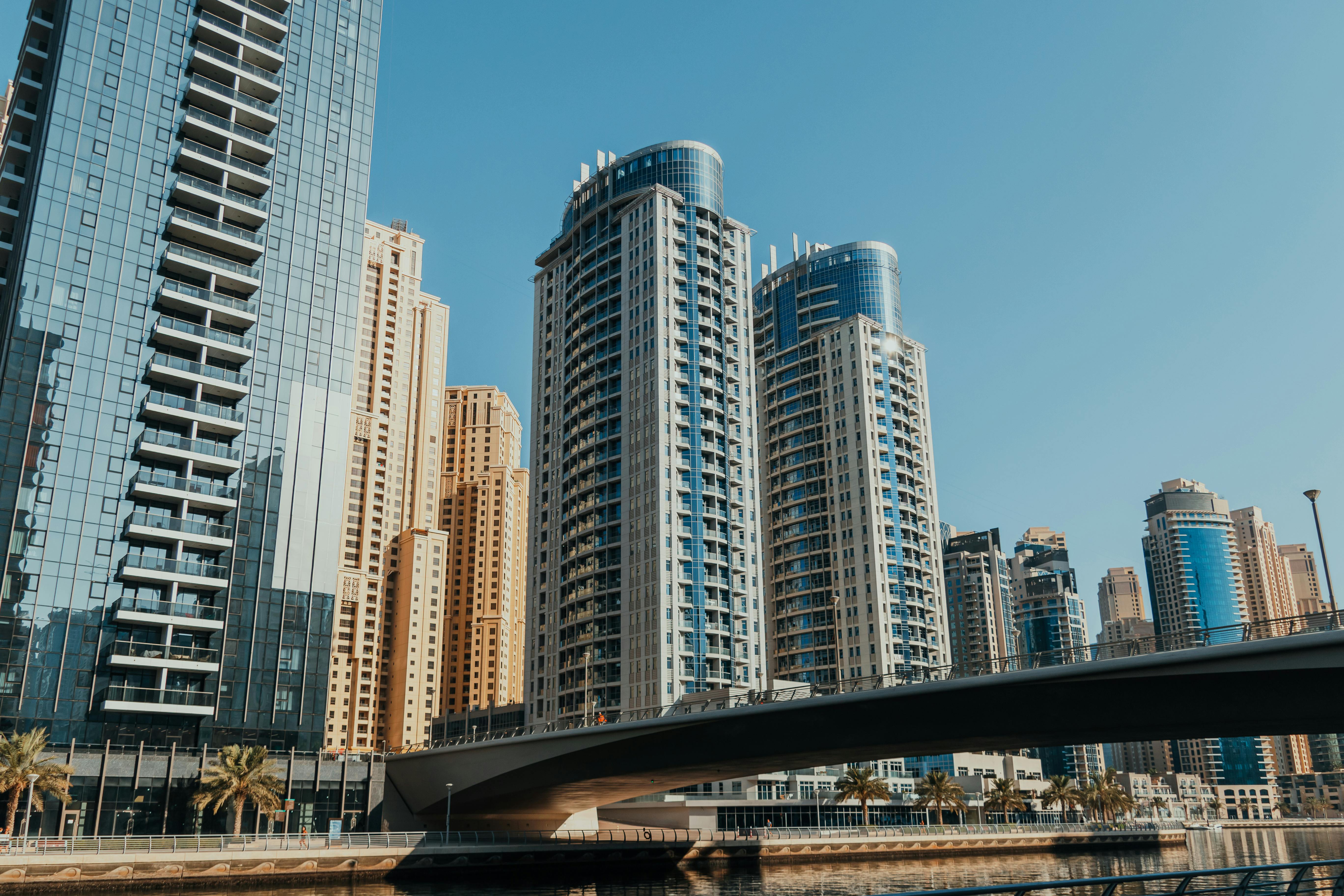 Modern tram navigating through pedestrian crosswalk bridge above ...
