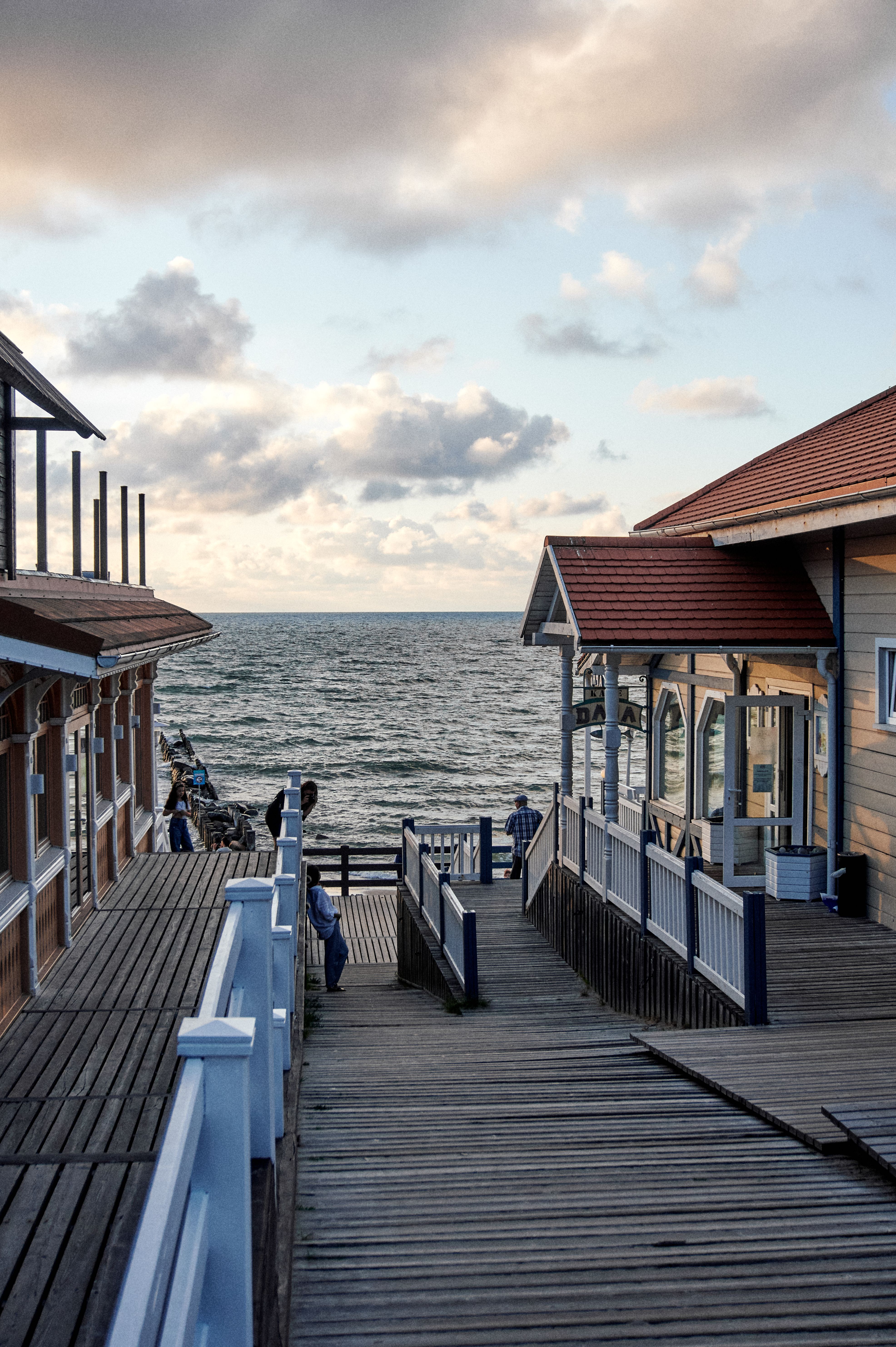 A pier with wooden stairs leading to the ocean · Free Stock Photo