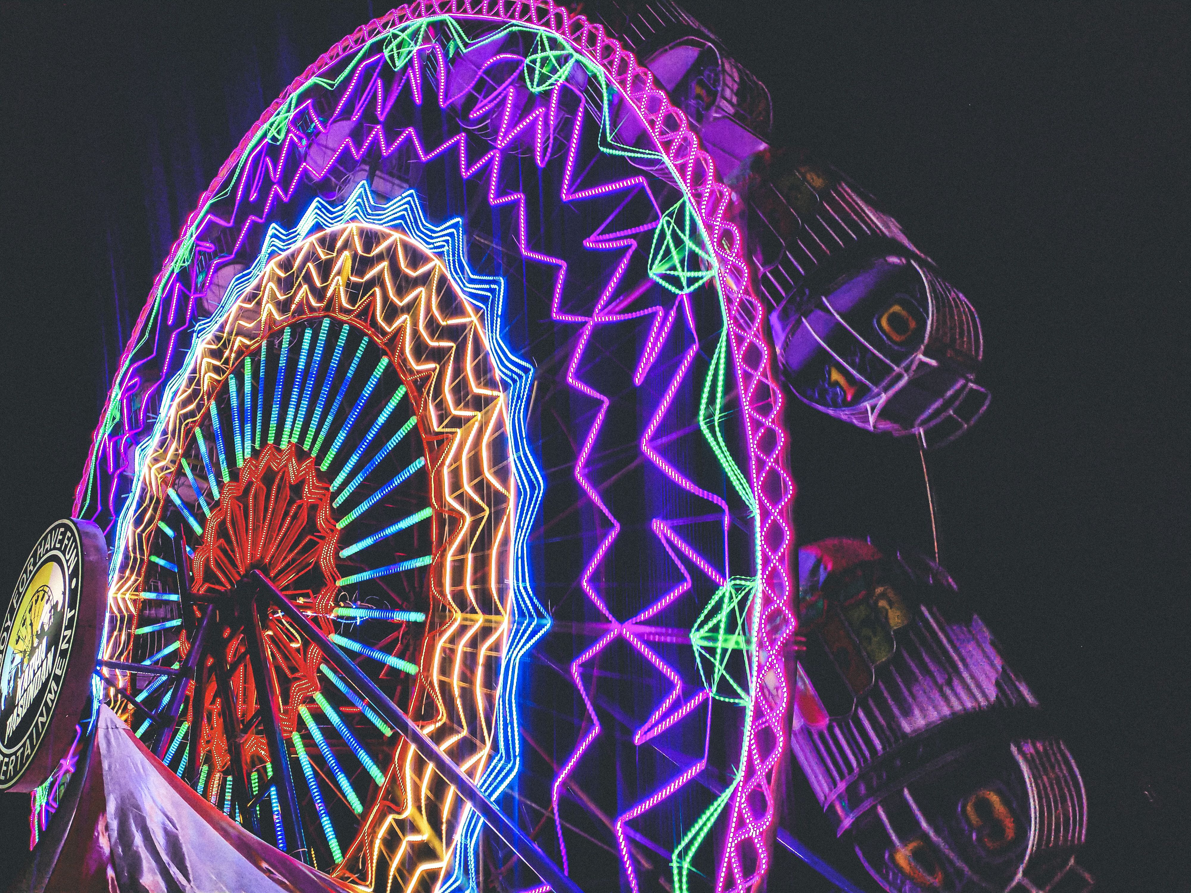A ferris wheel with colorful lights at night · Free Stock Photo