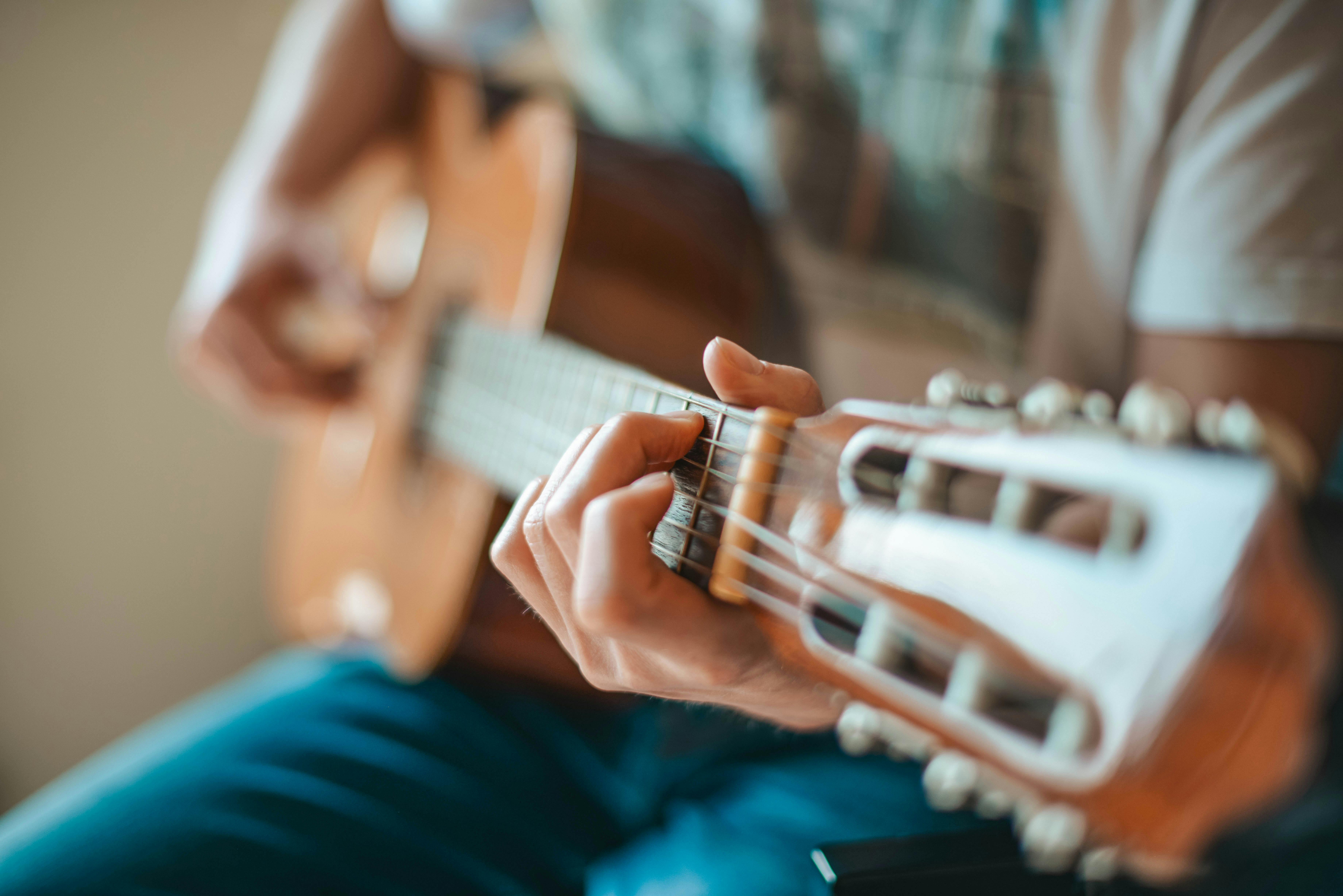 Person With Acoustic Guitar Standing in Green Field Near Mountain ...