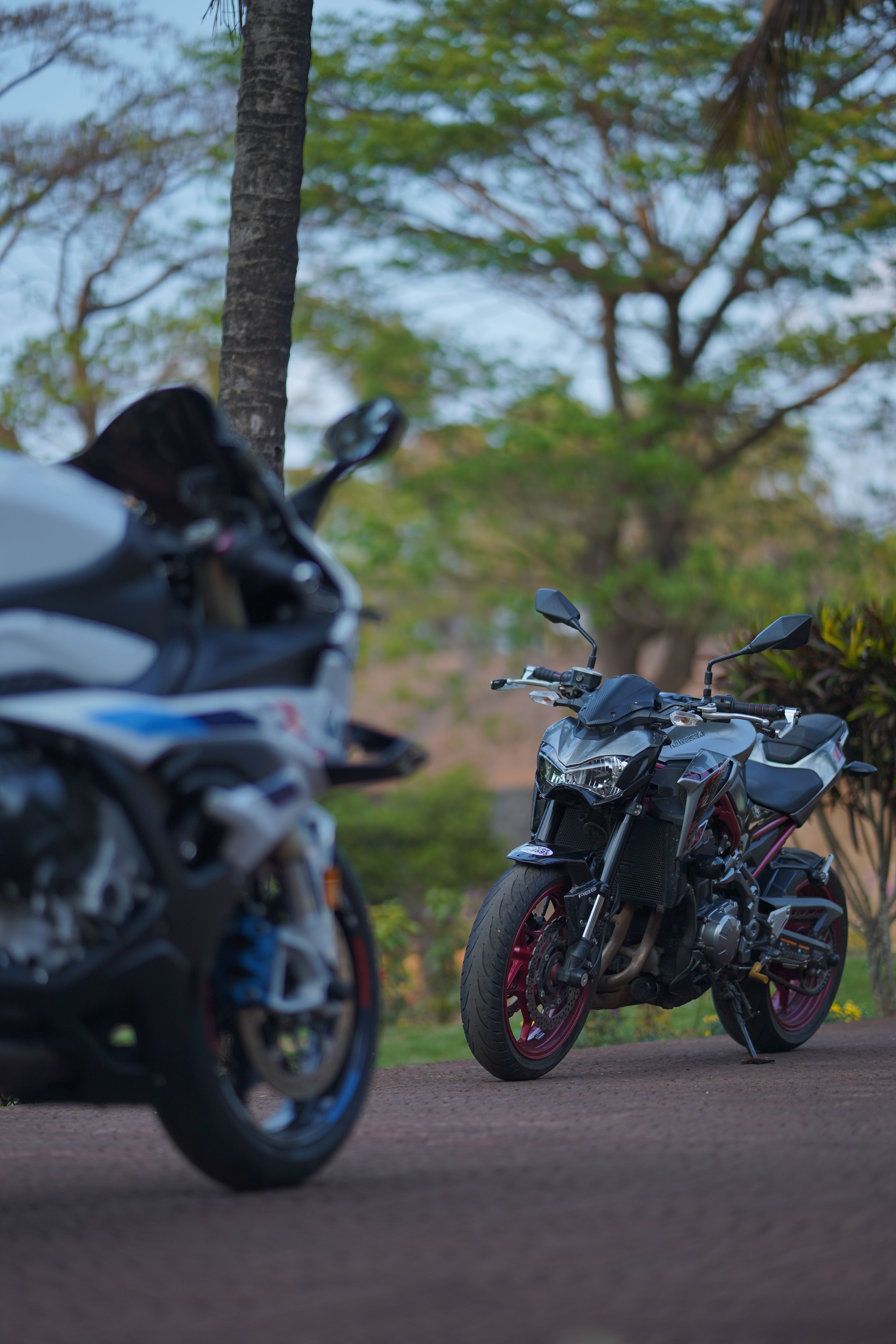 Two motorcycles parked next to each other on a paved road · Free Stock ...