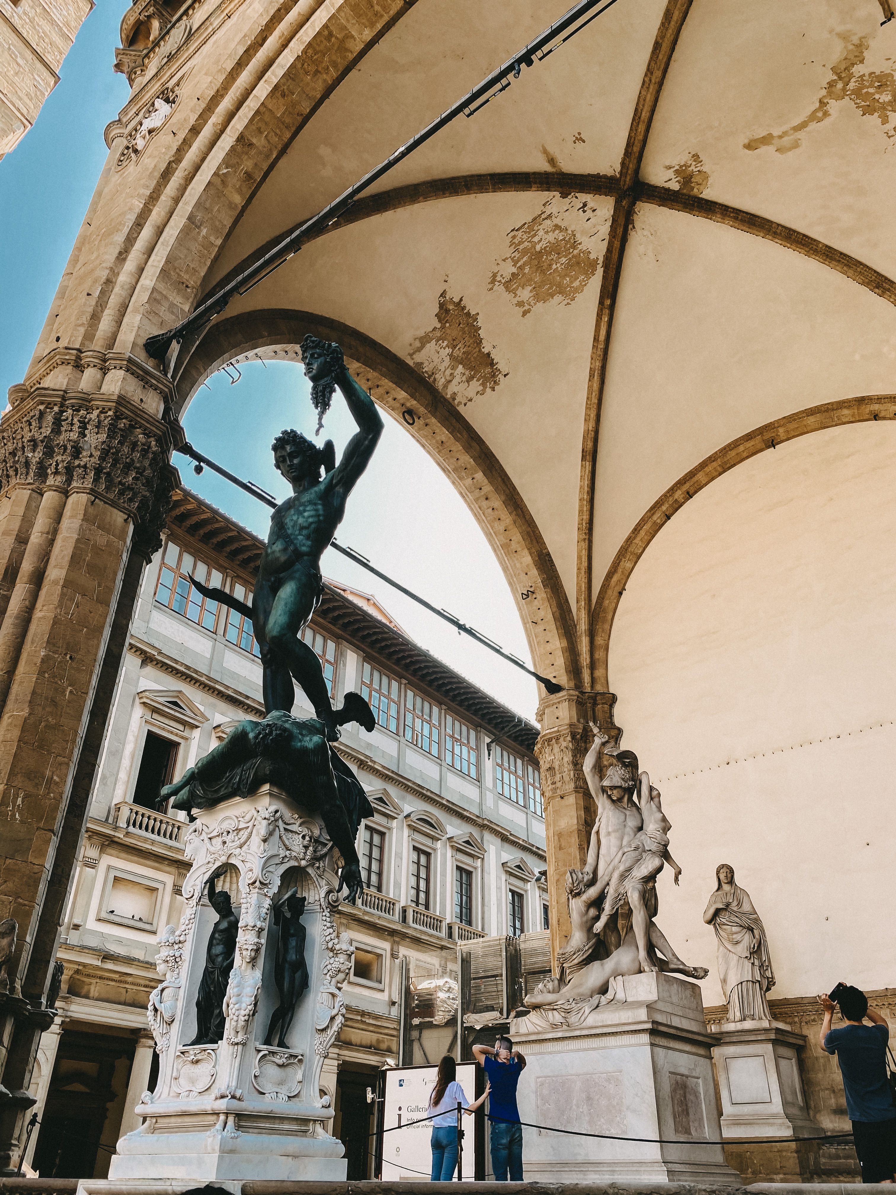 A statue of a man in a courtyard with a statue of a woman · Free Stock ...