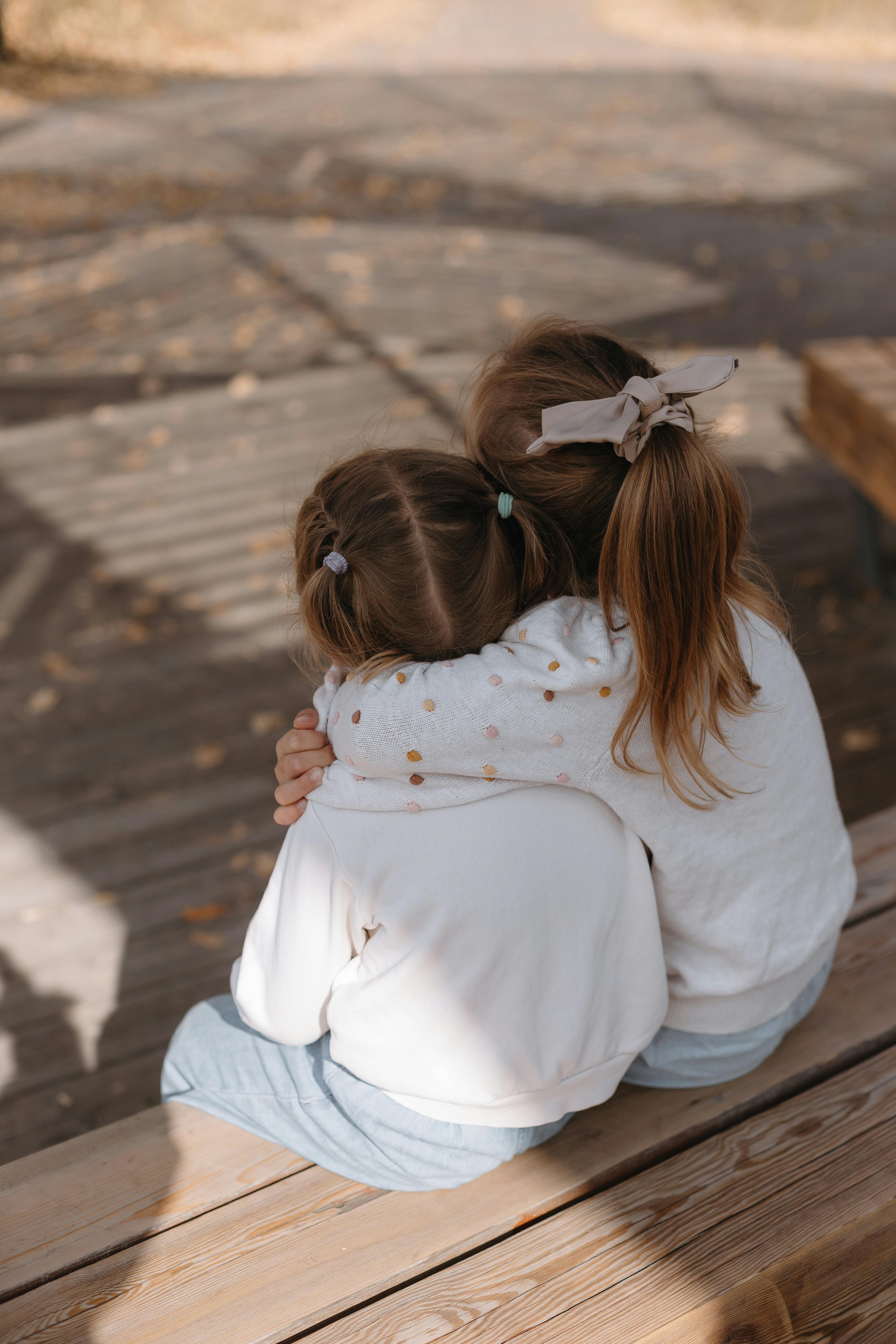 Girls Sitting and Hugging · Free Stock Photo