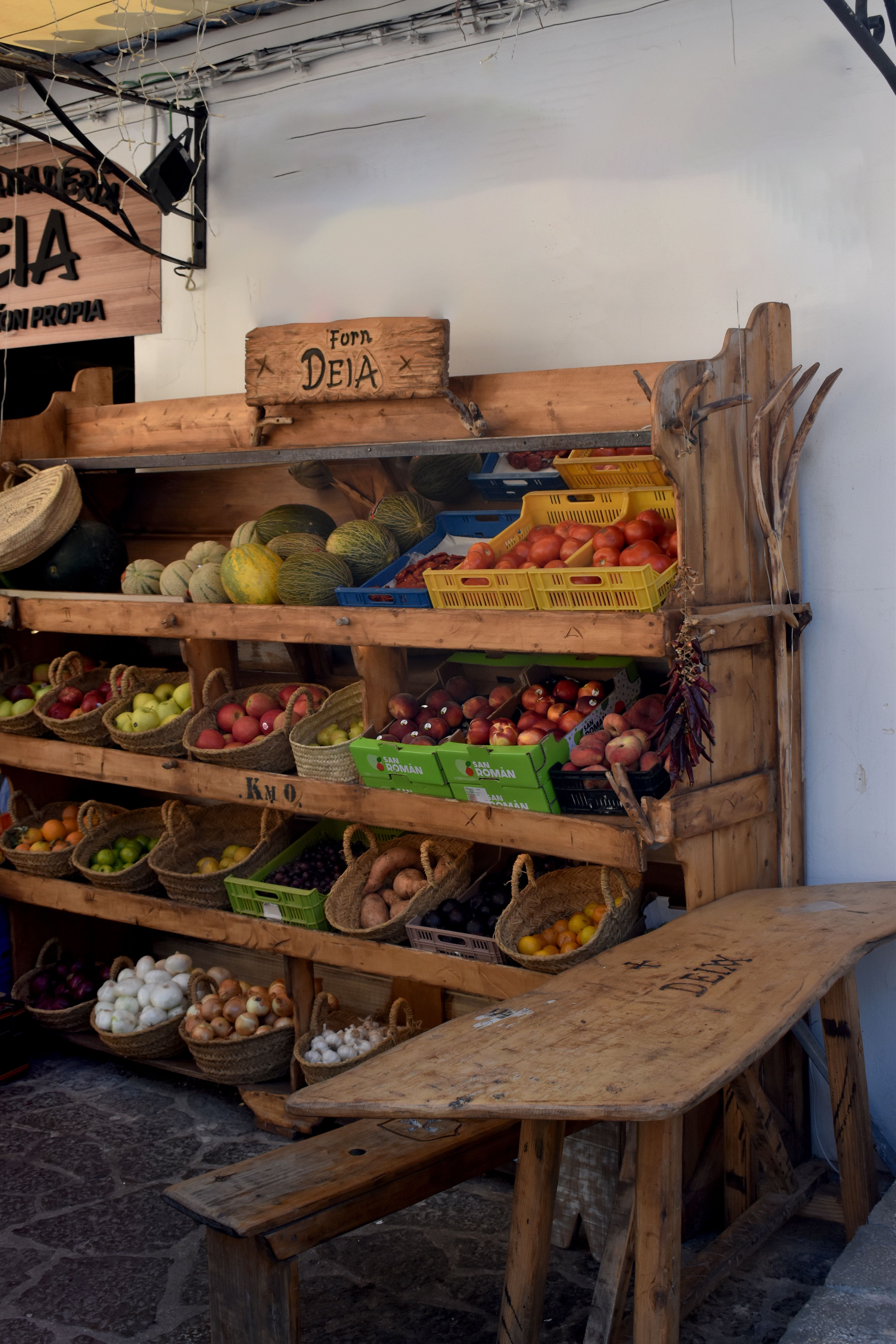 A fruit and vegetable stand with a variety of fruits and vegetables ...