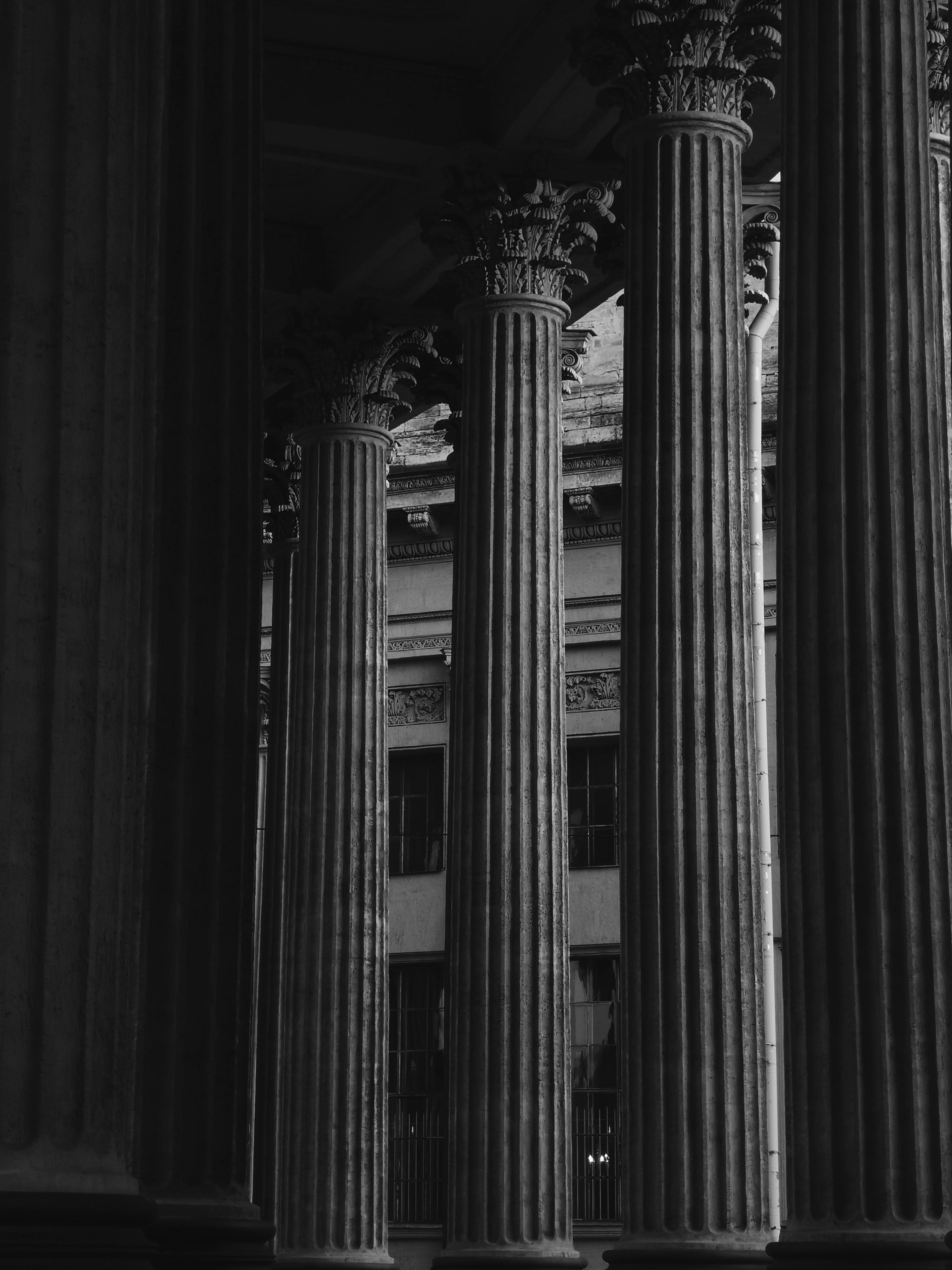 Black and white photograph of columns in a building · Free Stock Photo
