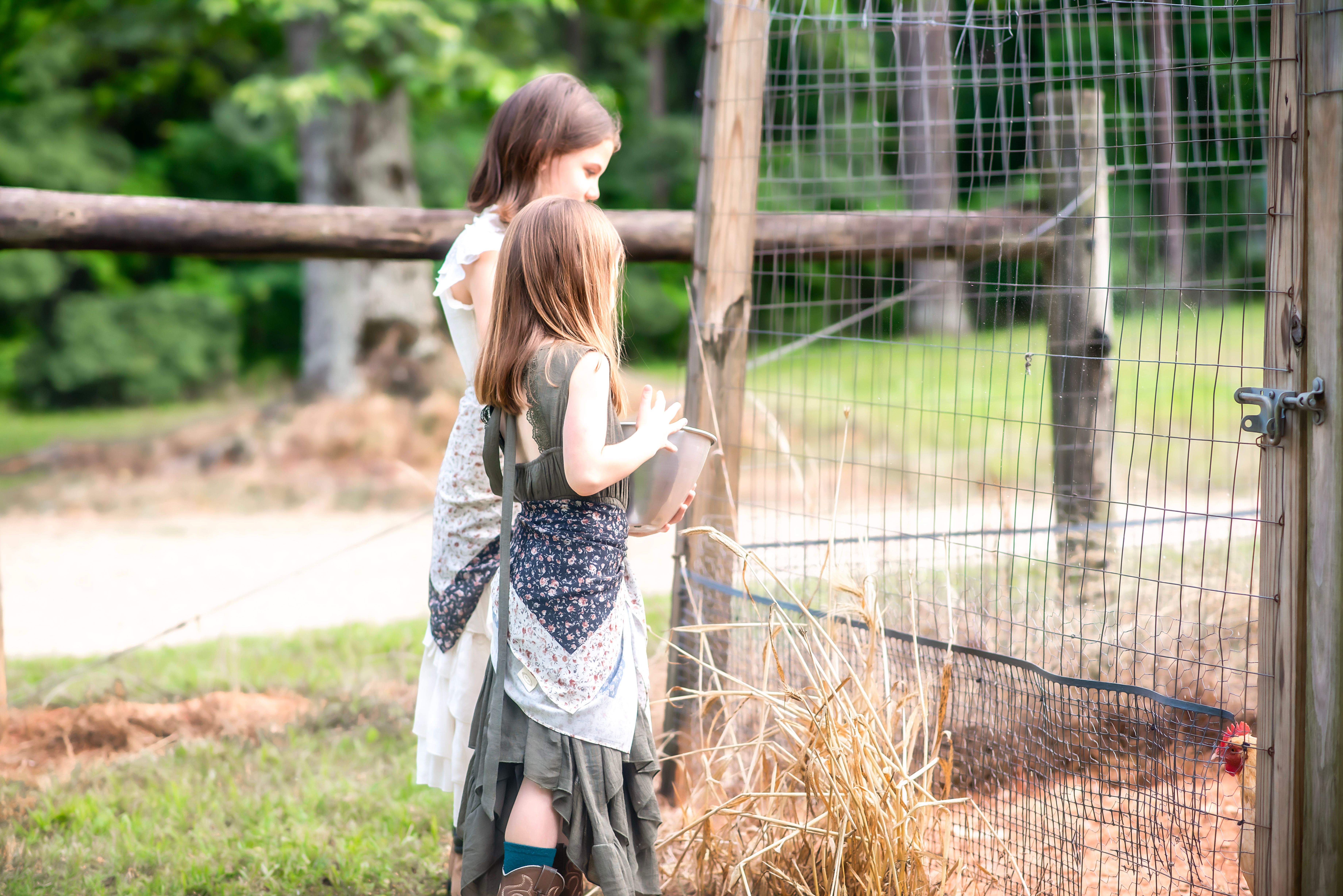 Sisters at the chicken coup · Free Stock Photo