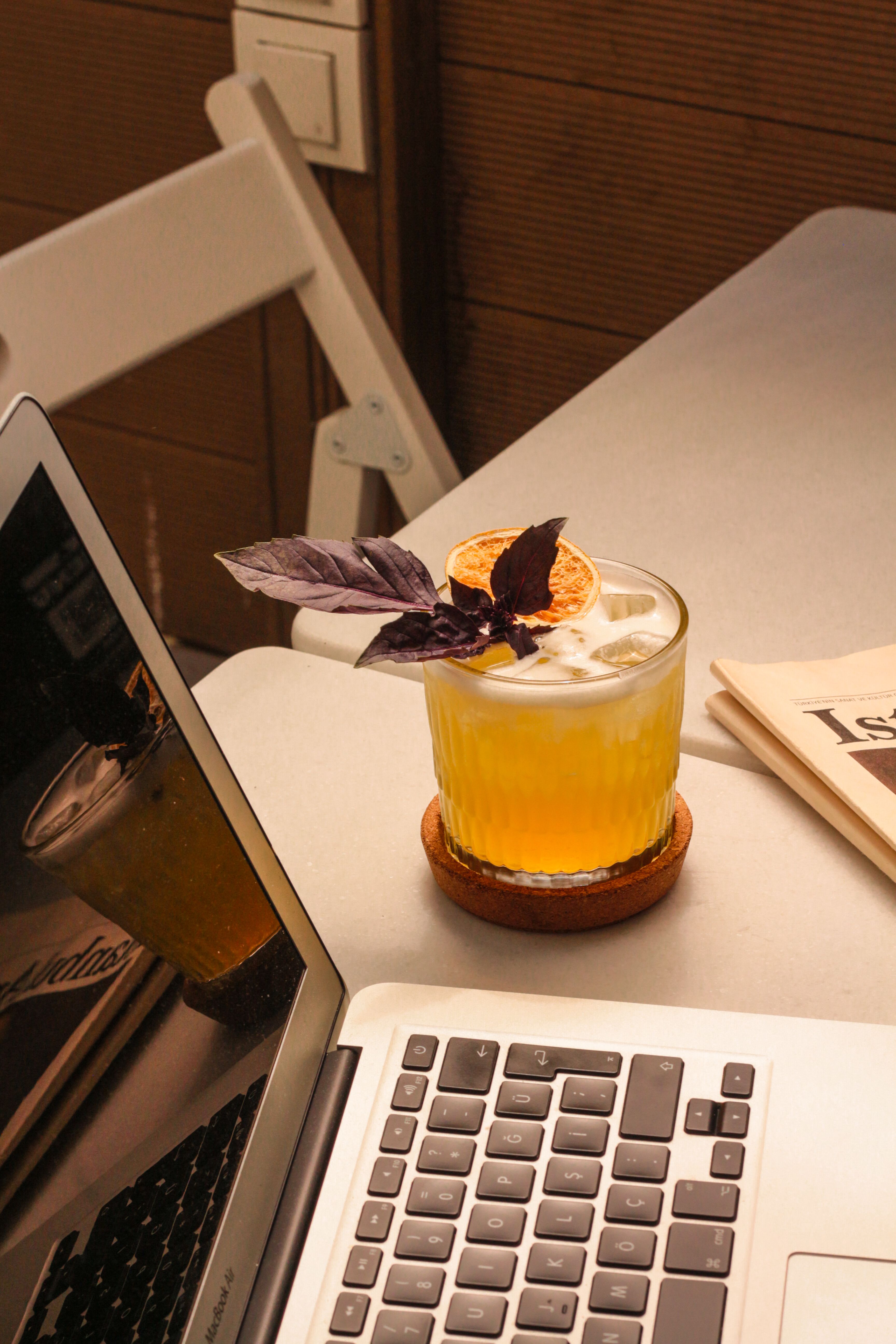 A laptop computer and a drink on a table · Free Stock Photo