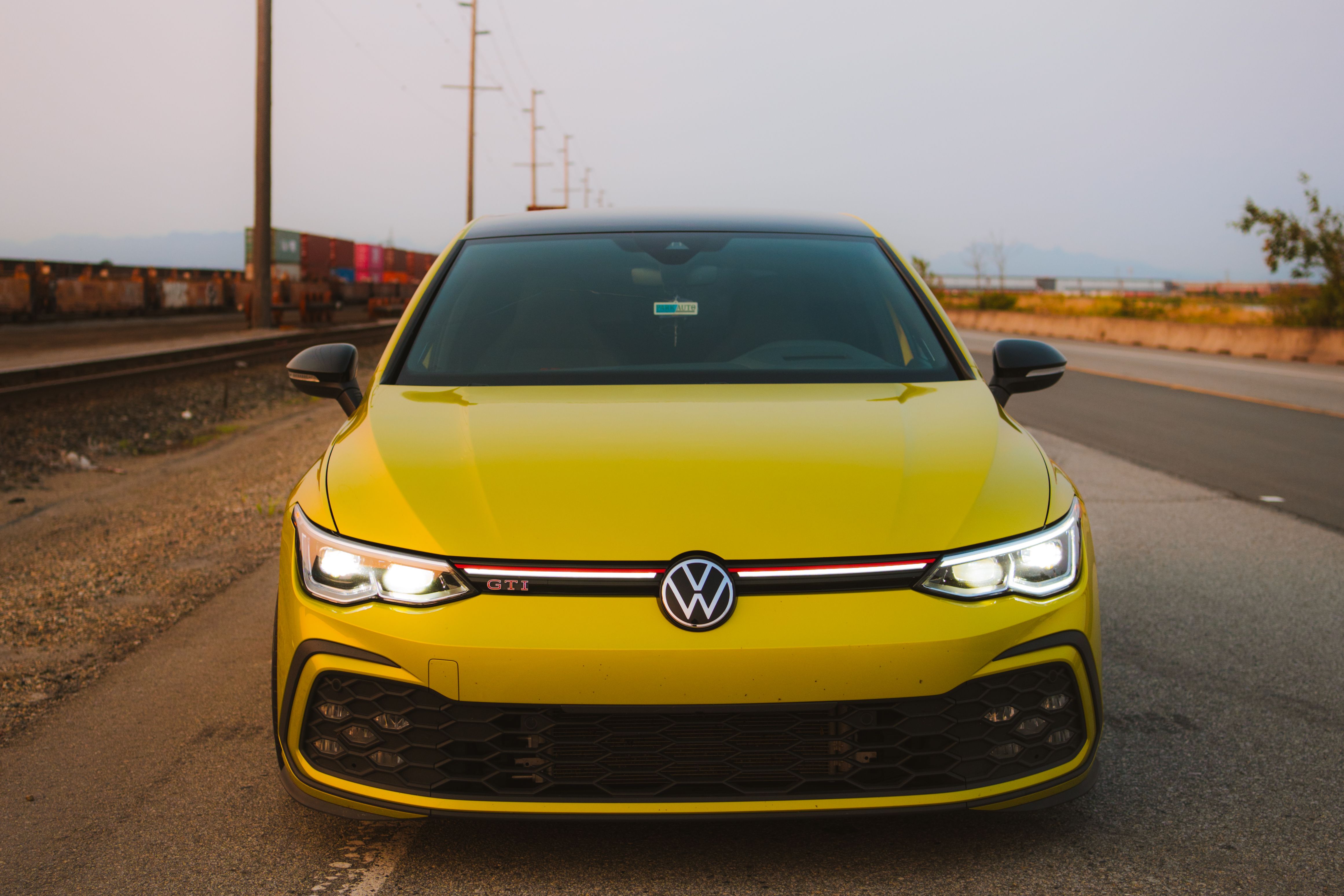 The front end of a yellow volkswagen golf · Free Stock Photo