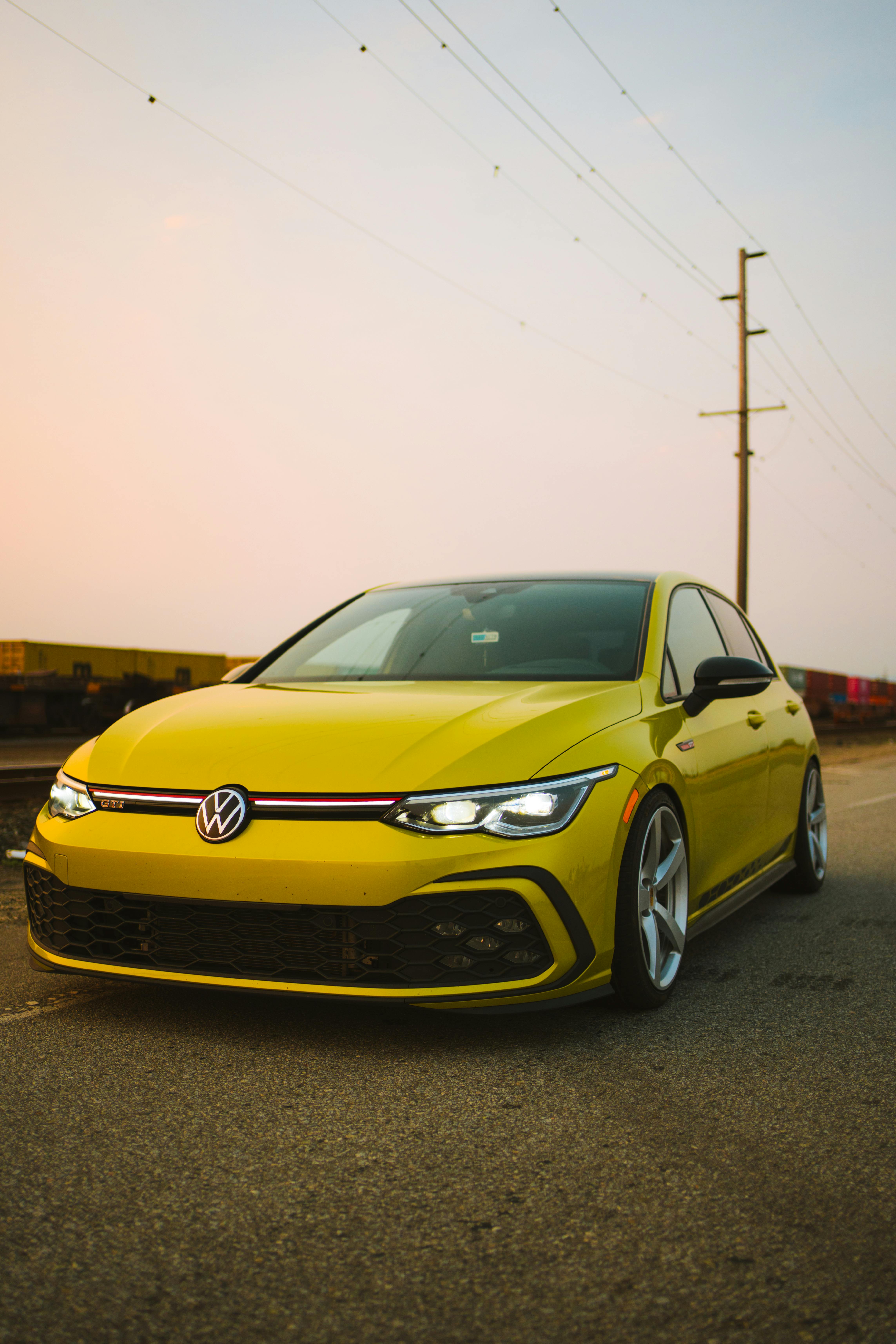 The front end of a yellow volkswagen golf · Free Stock Photo