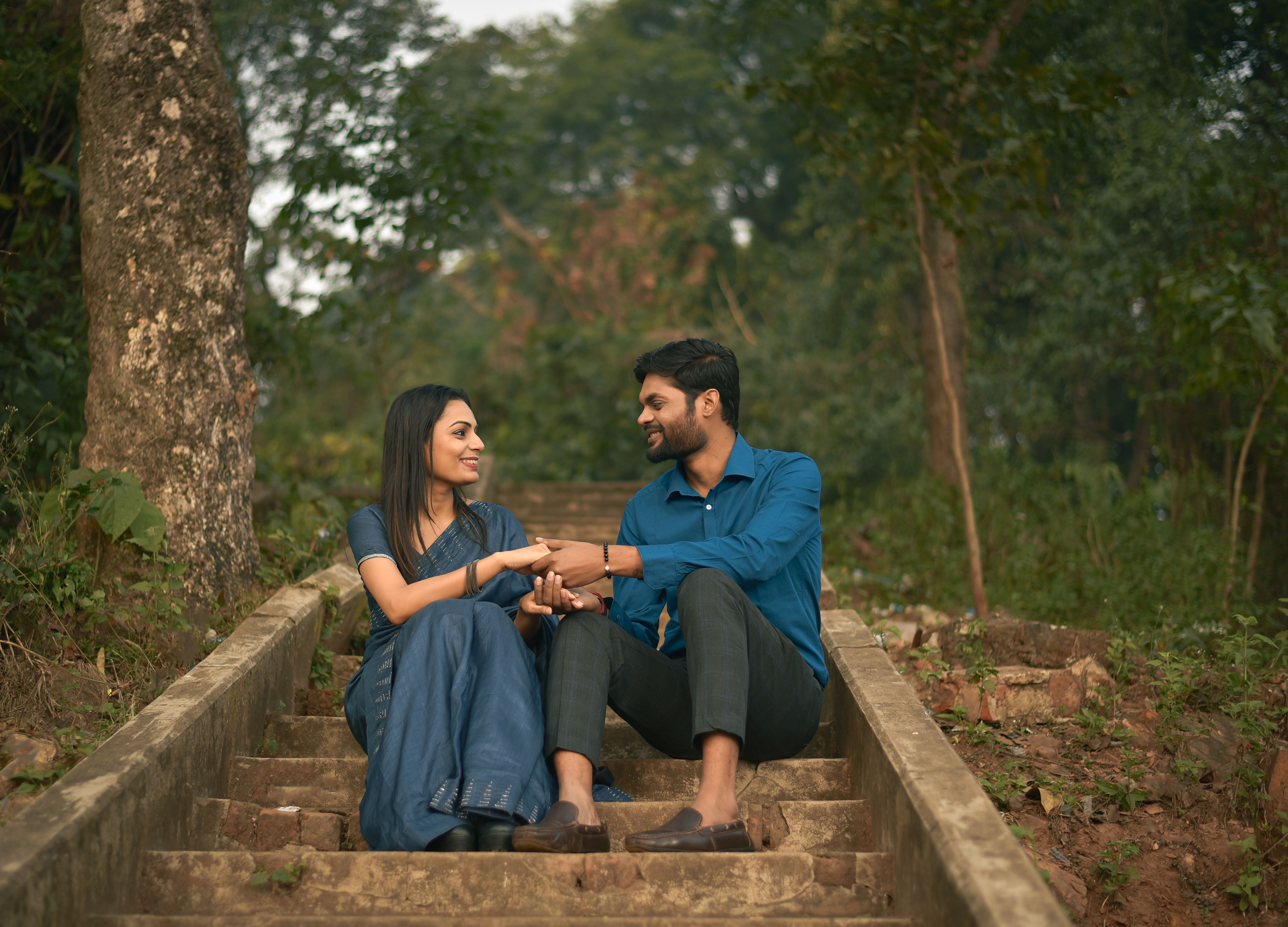 A couple sitting on the steps in the forest · Free Stock Photo
