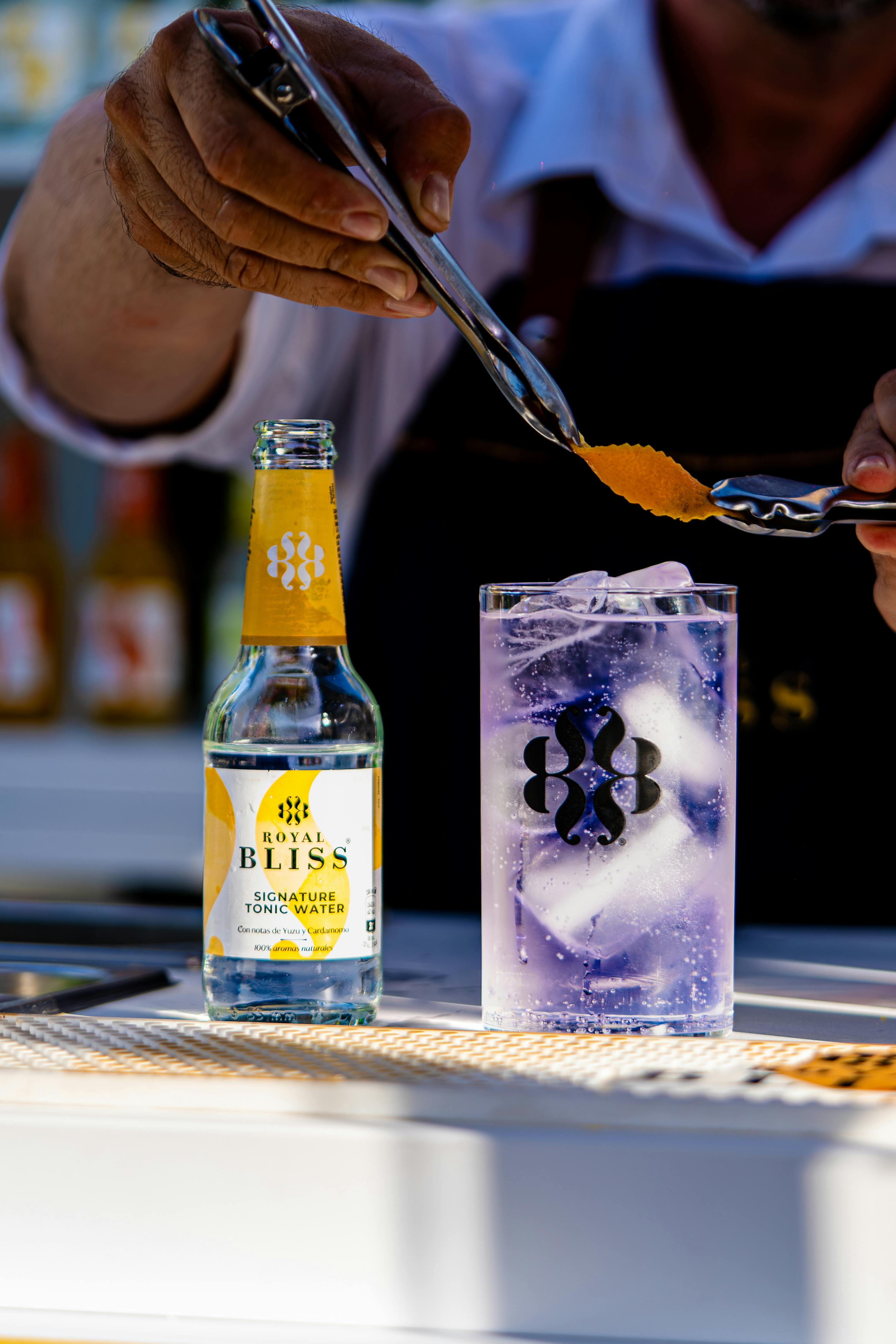 A man is pouring a drink into a glass · Free Stock Photo