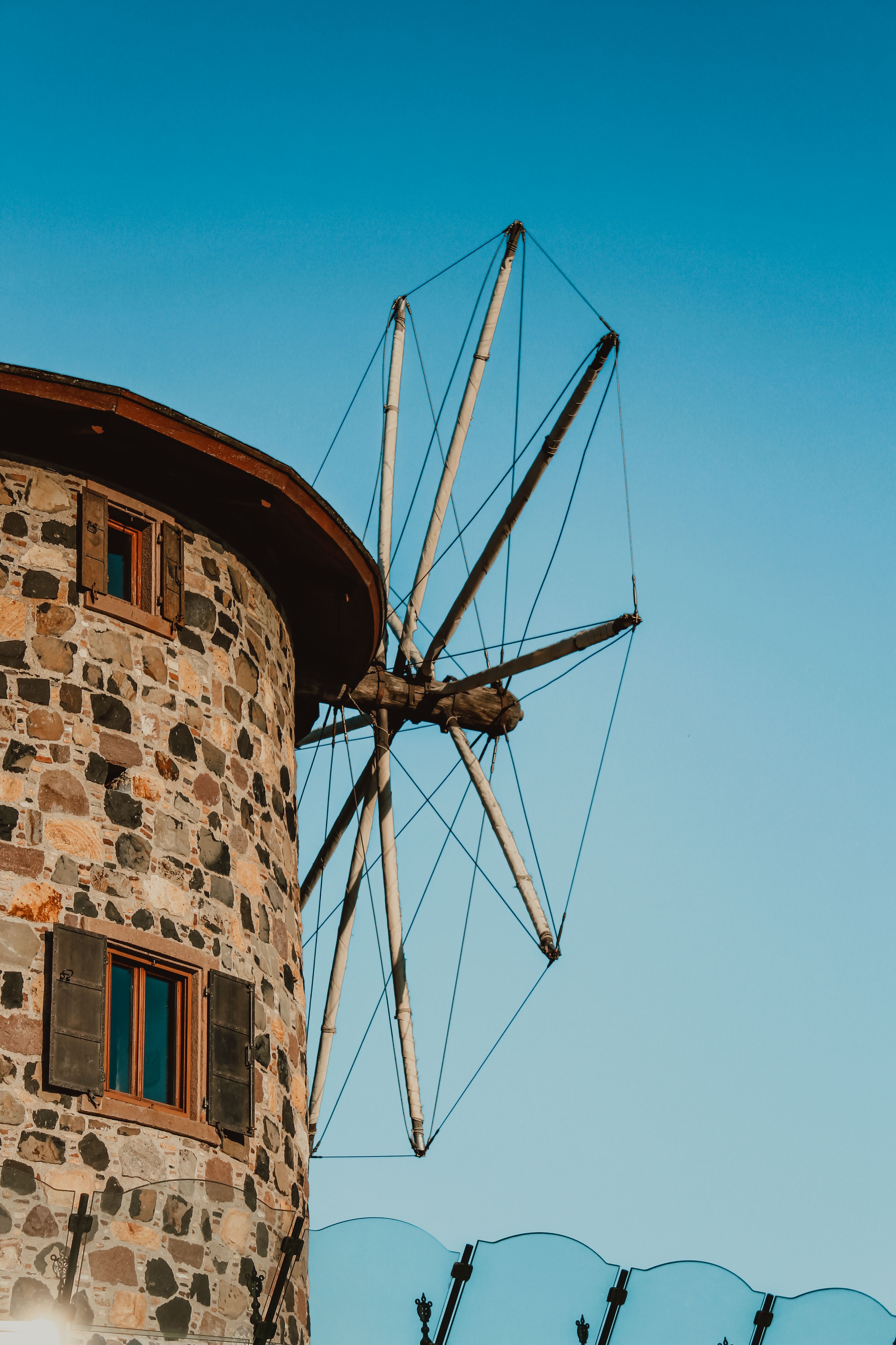 A windmill is on the side of a building · Free Stock Photo