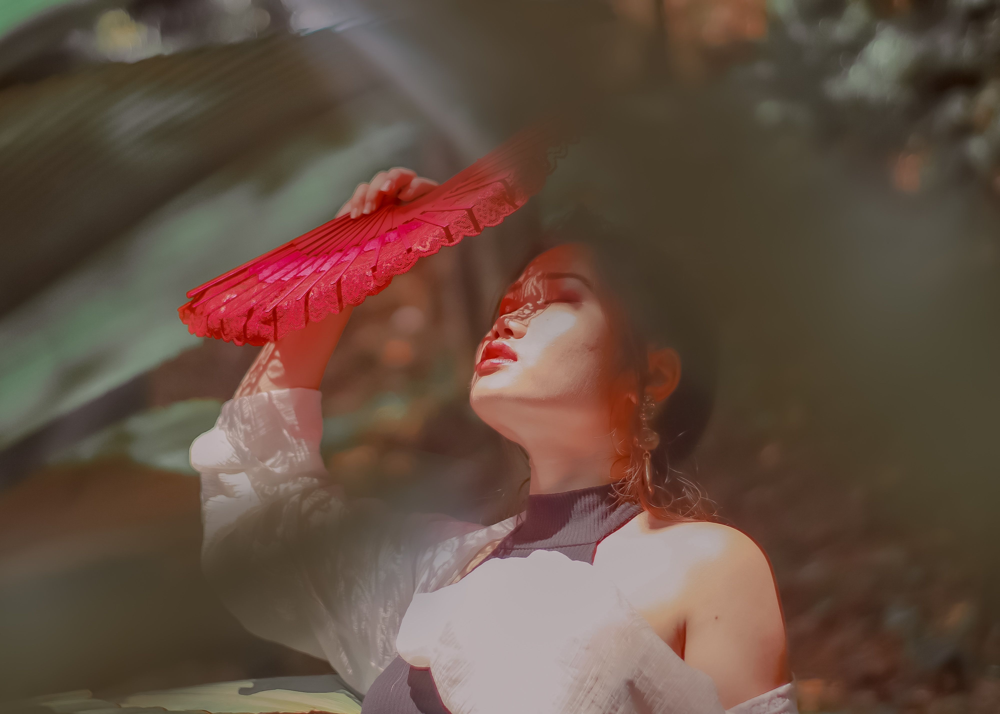 Woman Holding a Fan · Free Stock Photo