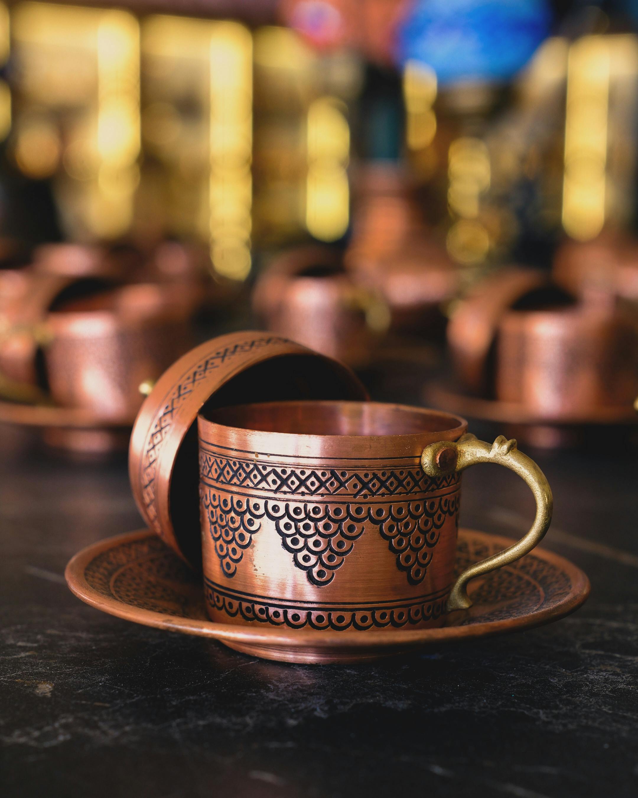 Copper tea cups and saucers on a table · Free Stock Photo