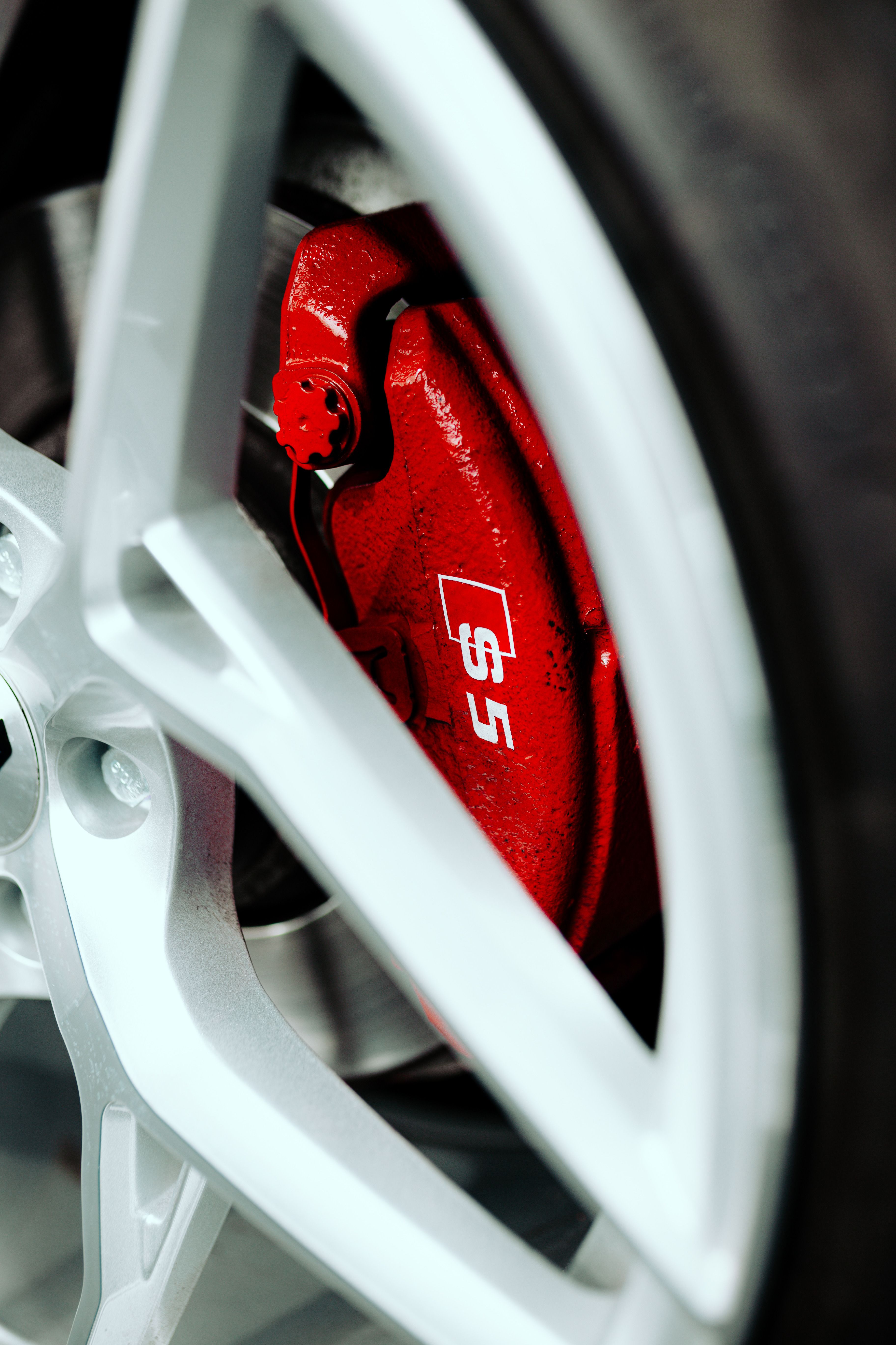 A close up of a red brake disc on a car · Free Stock Photo