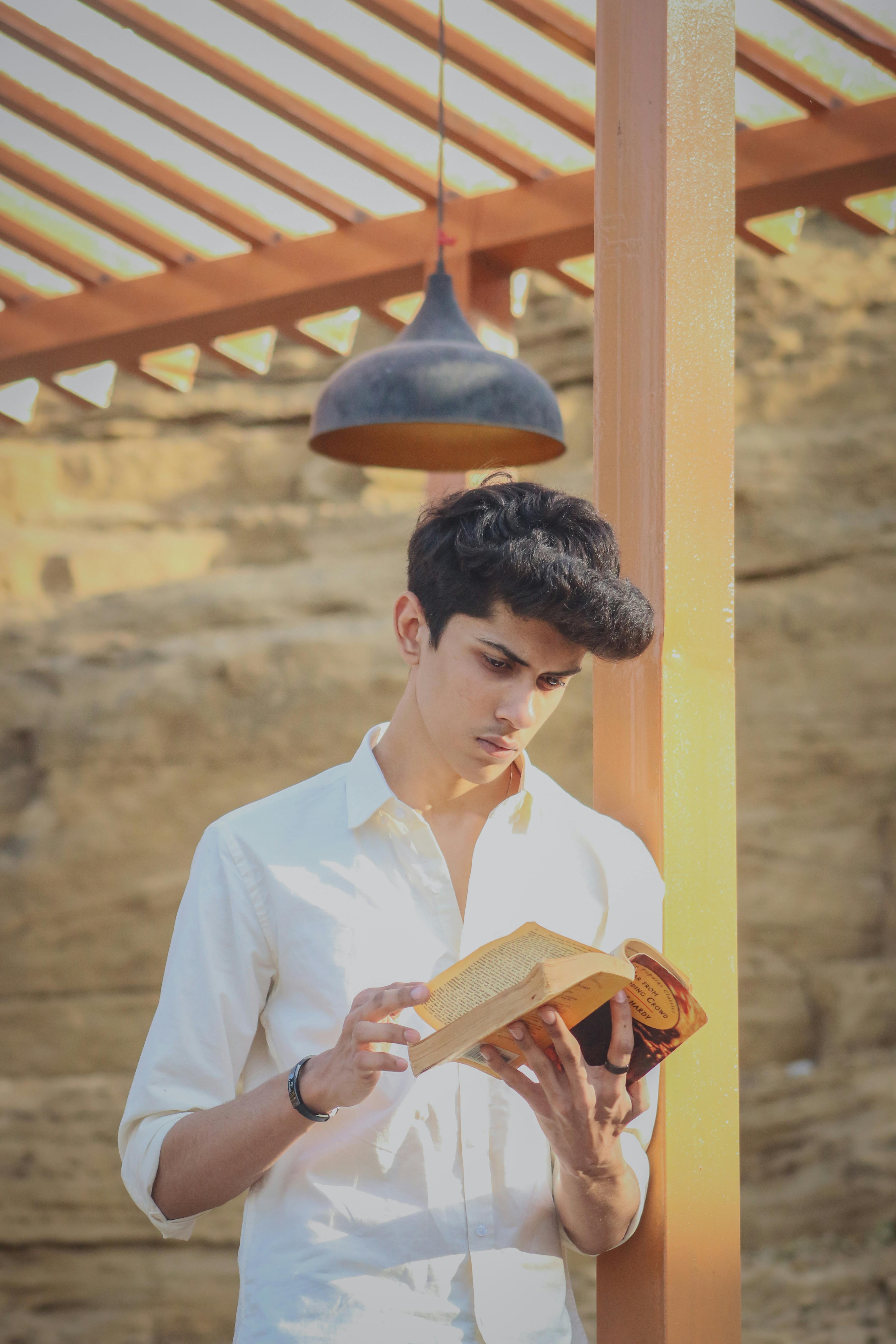 Man Wearing Black Suit Reading Book · Free Stock Photo