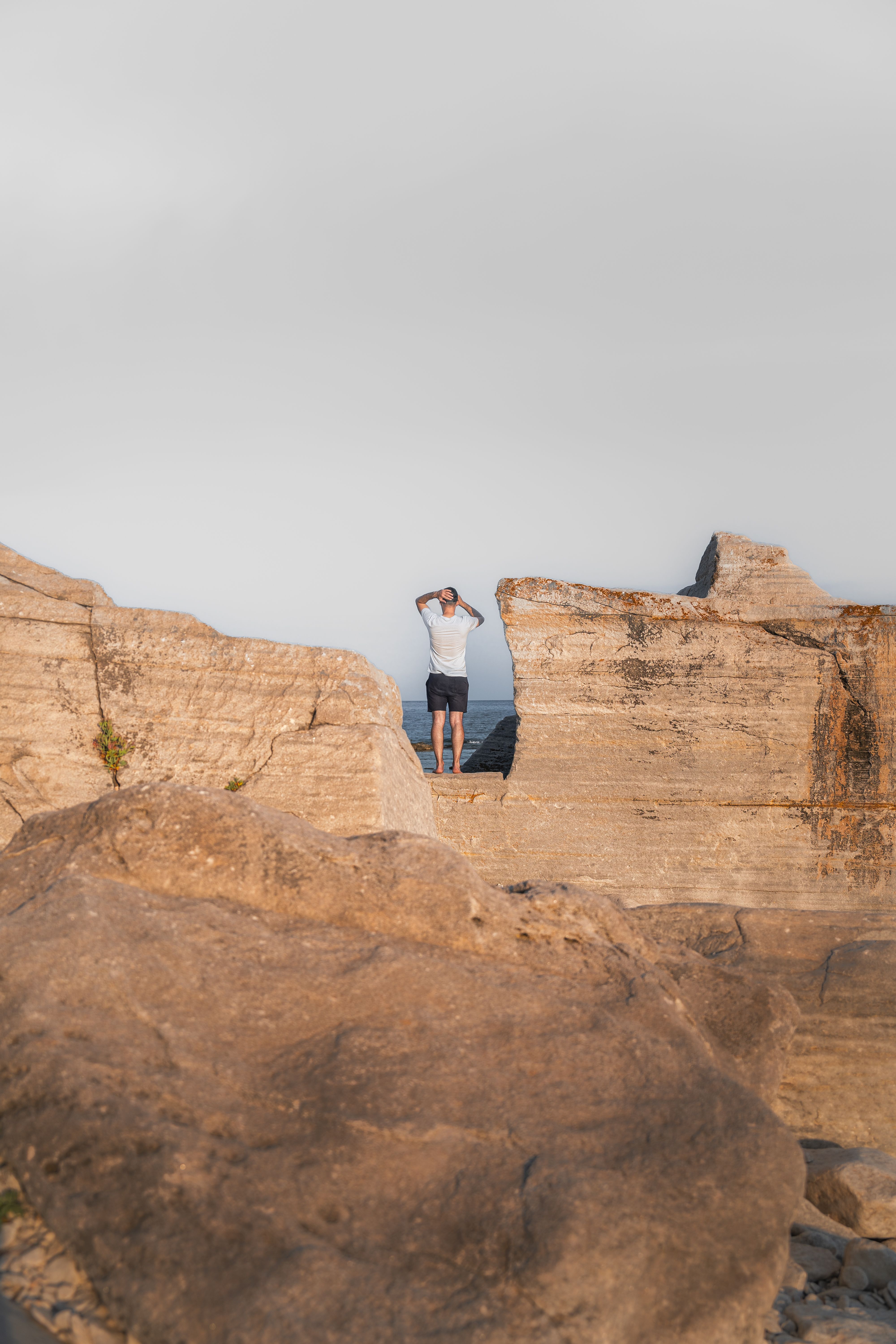 Person Standing Between Large Rocks · Free Stock Photo
