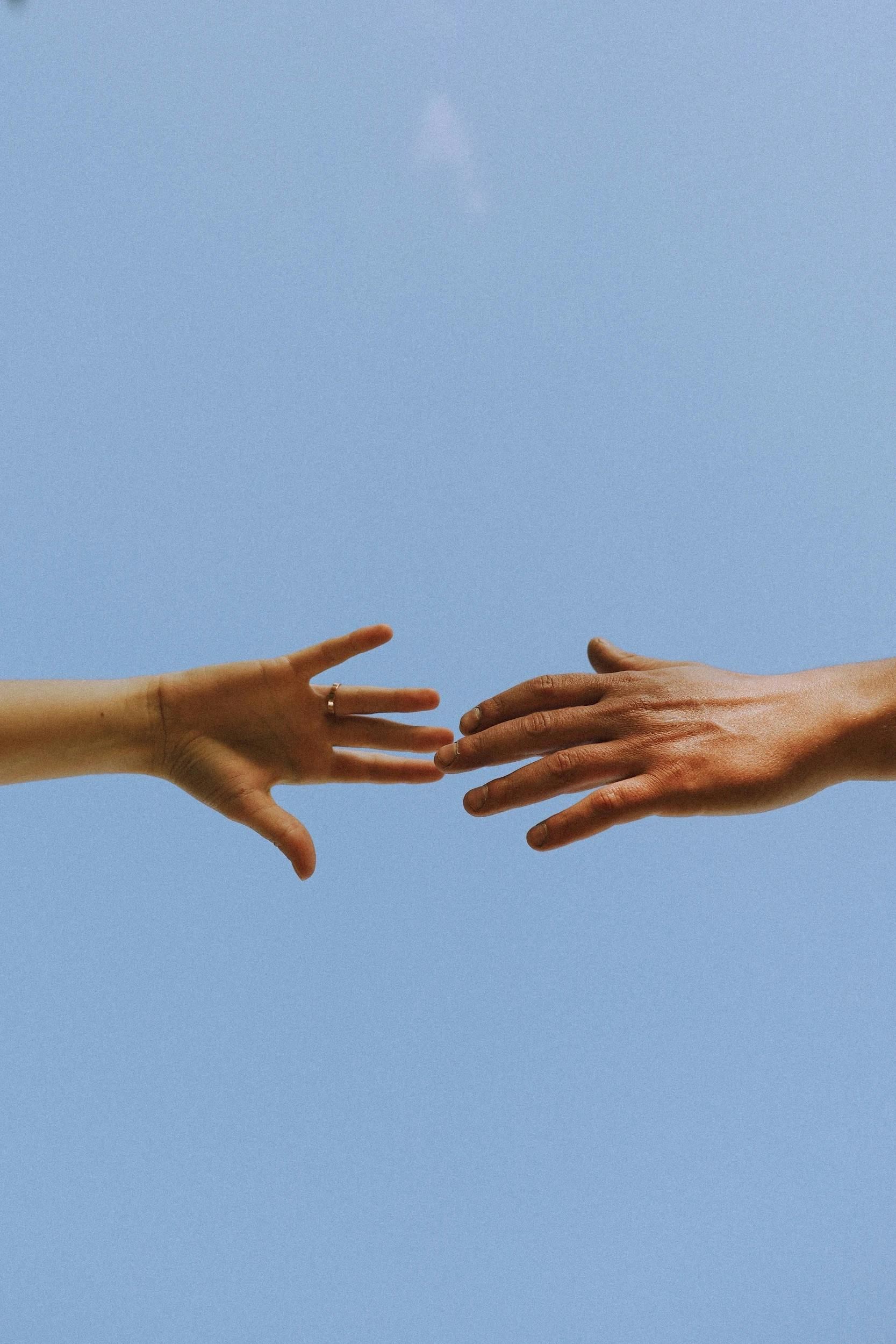 Photo Of People Reaching Each Other's Hands · Free Stock Photo