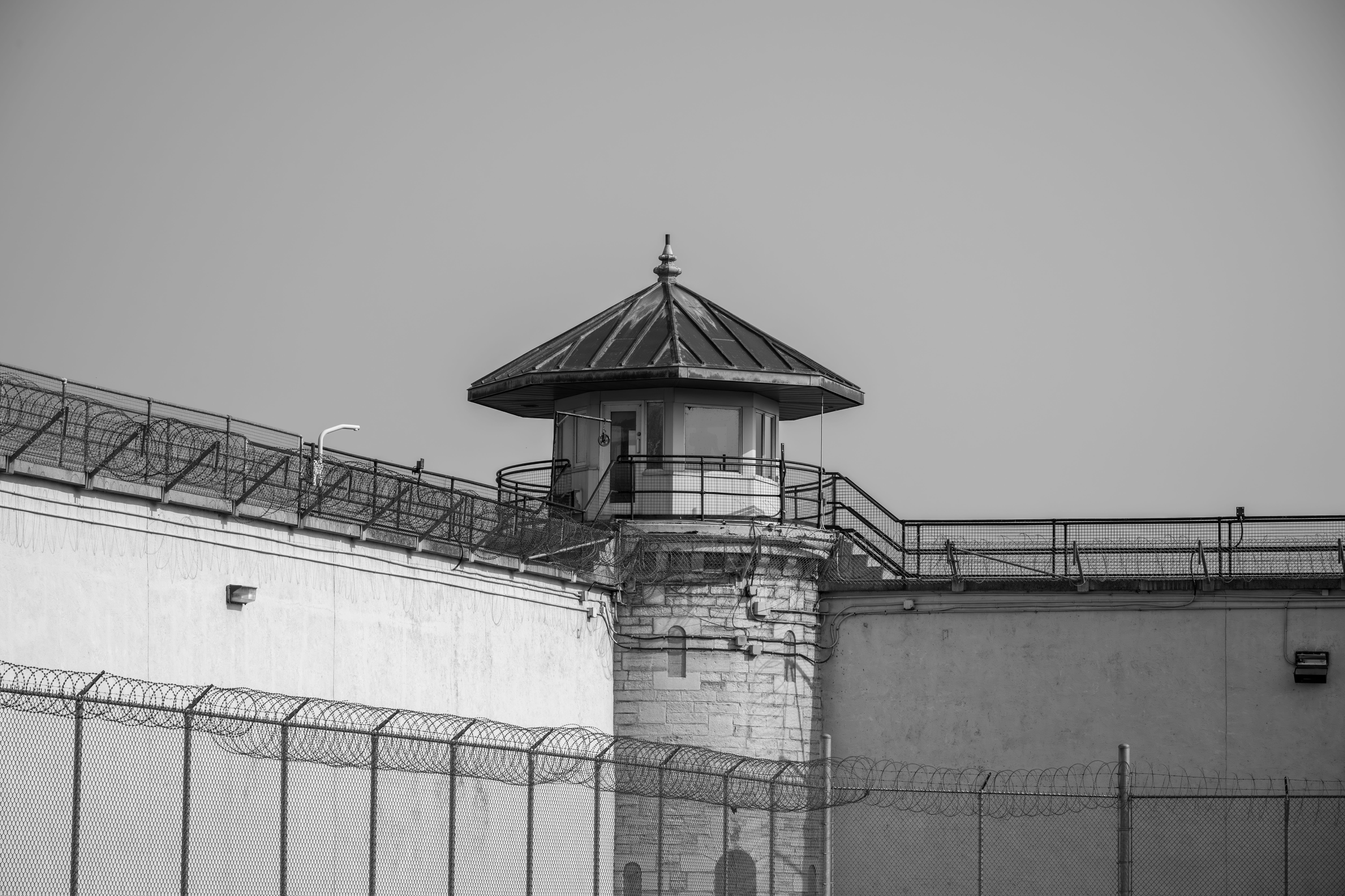 Prison Watchtower with Barbed Wire and Blue Sky · Free Stock Photo