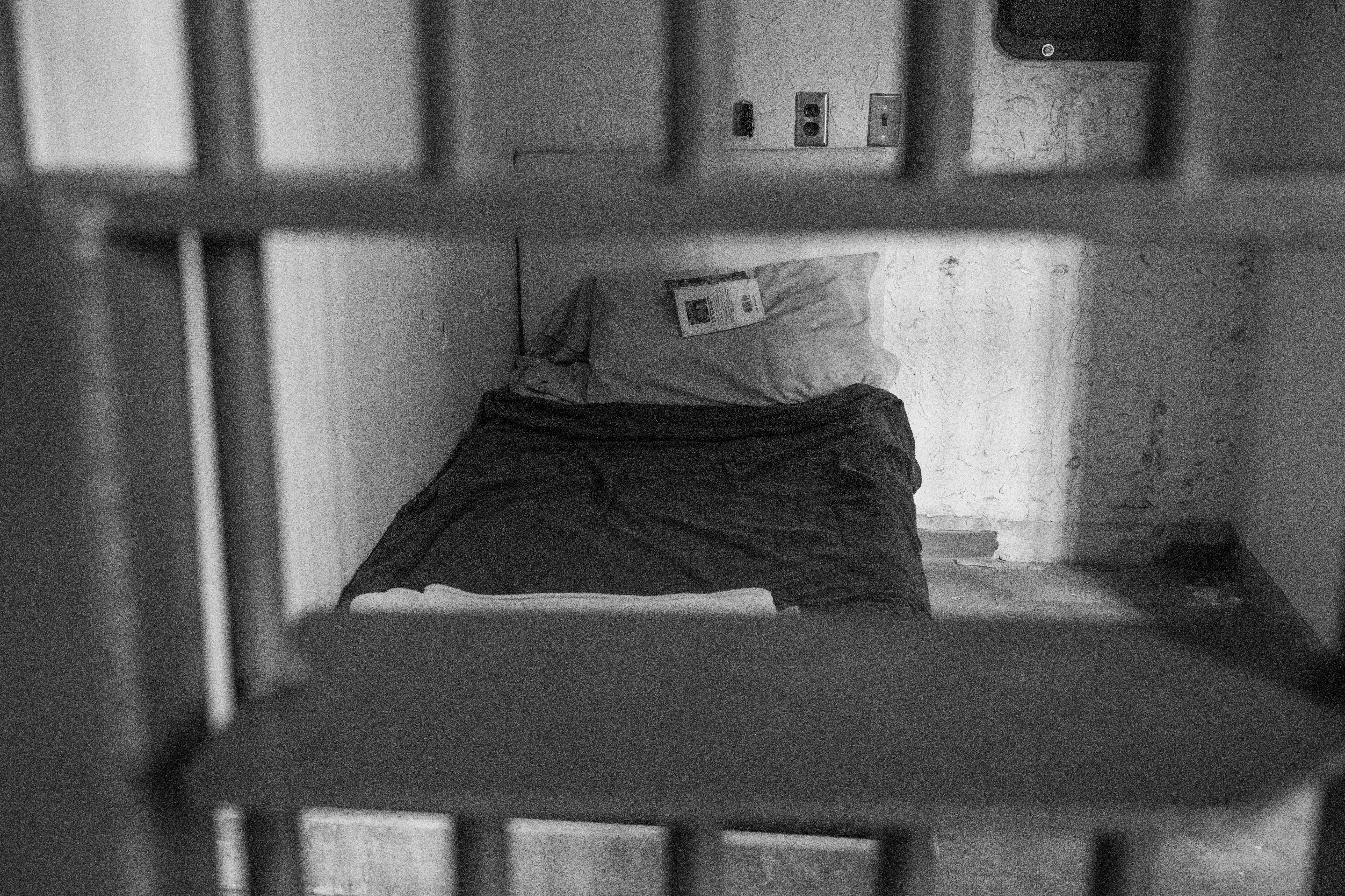 A bed in a jail cell · Free Stock Photo