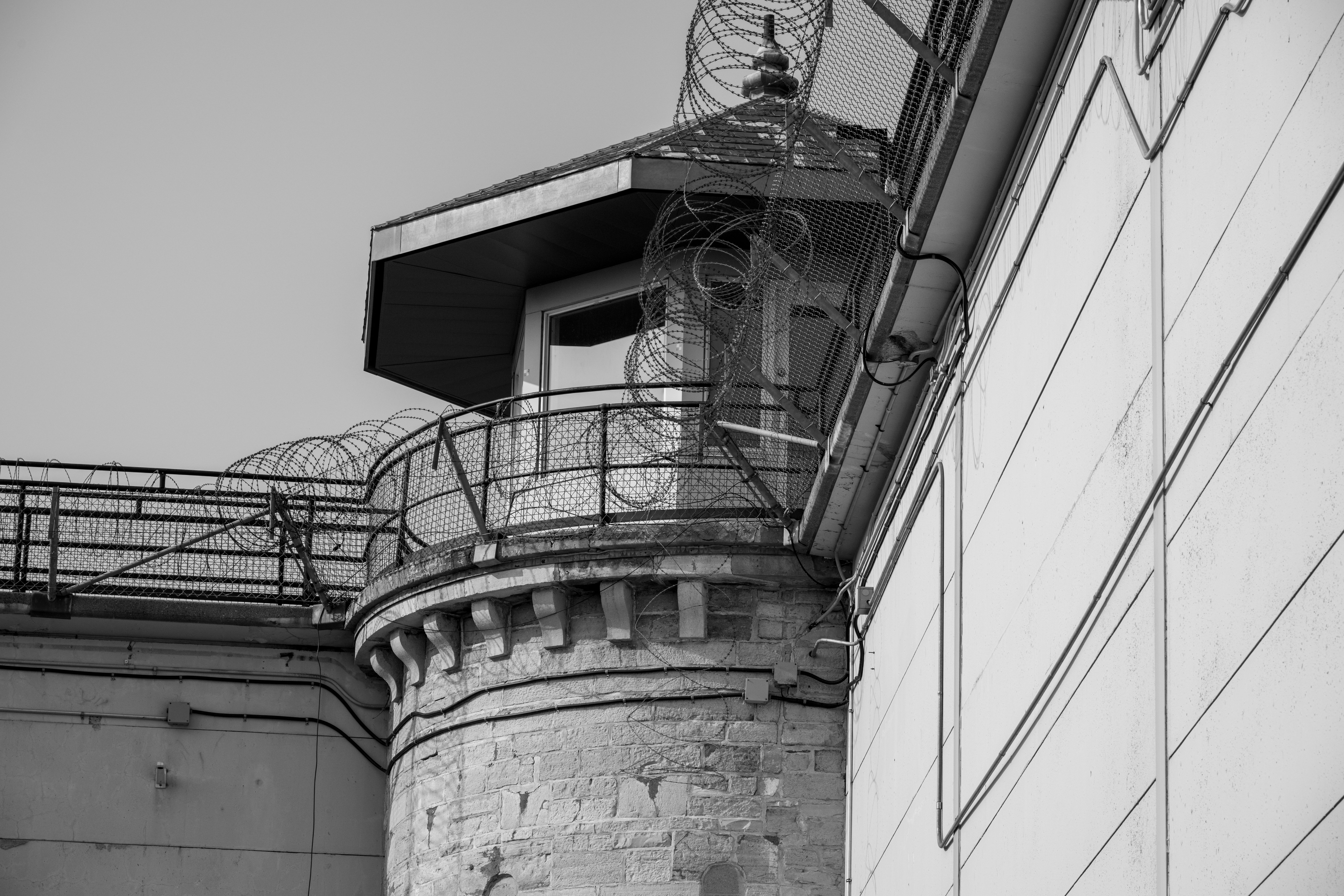 A black and white photo of a prison tower · Free Stock Photo