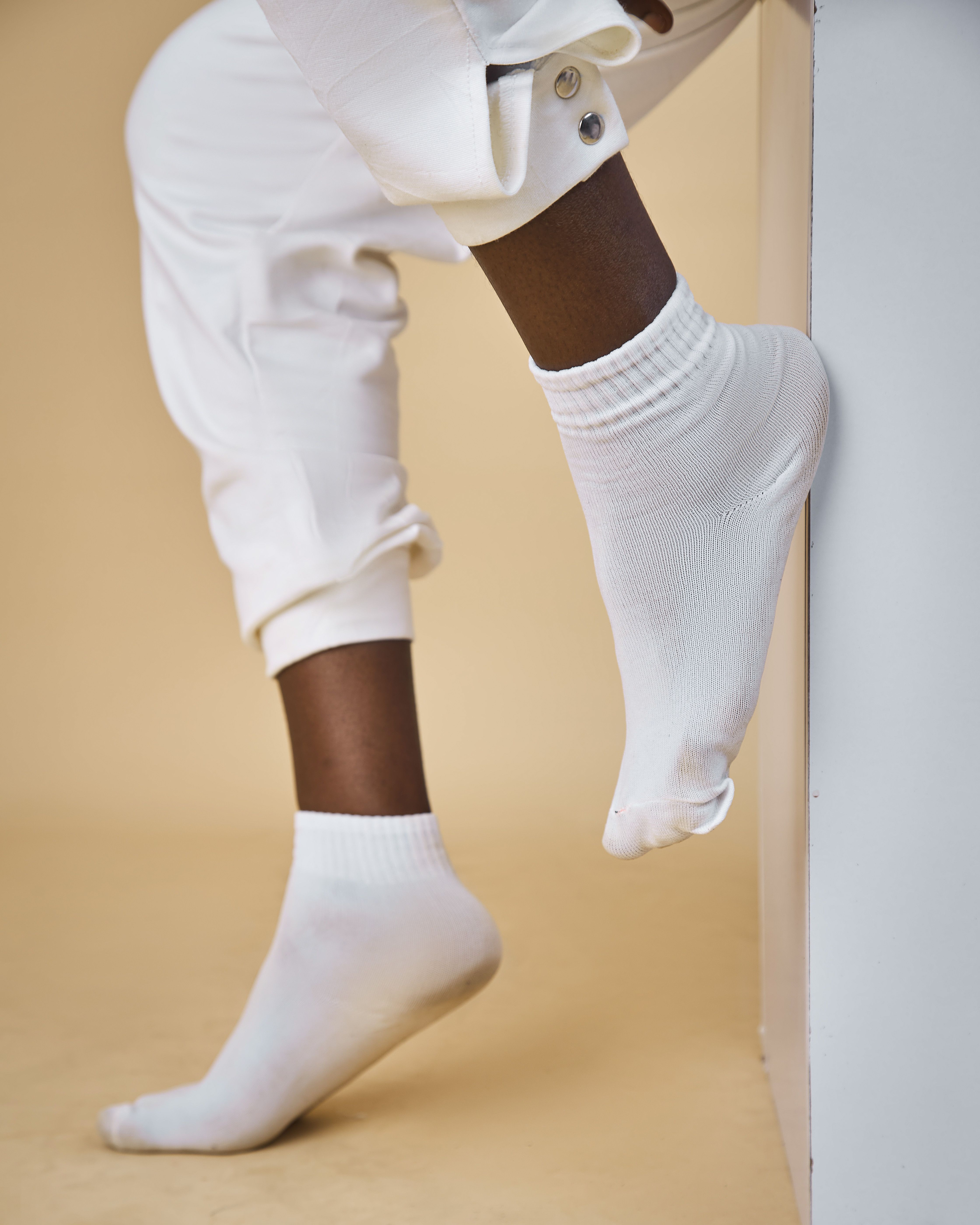 A person wearing white socks and shoes · Free Stock Photo