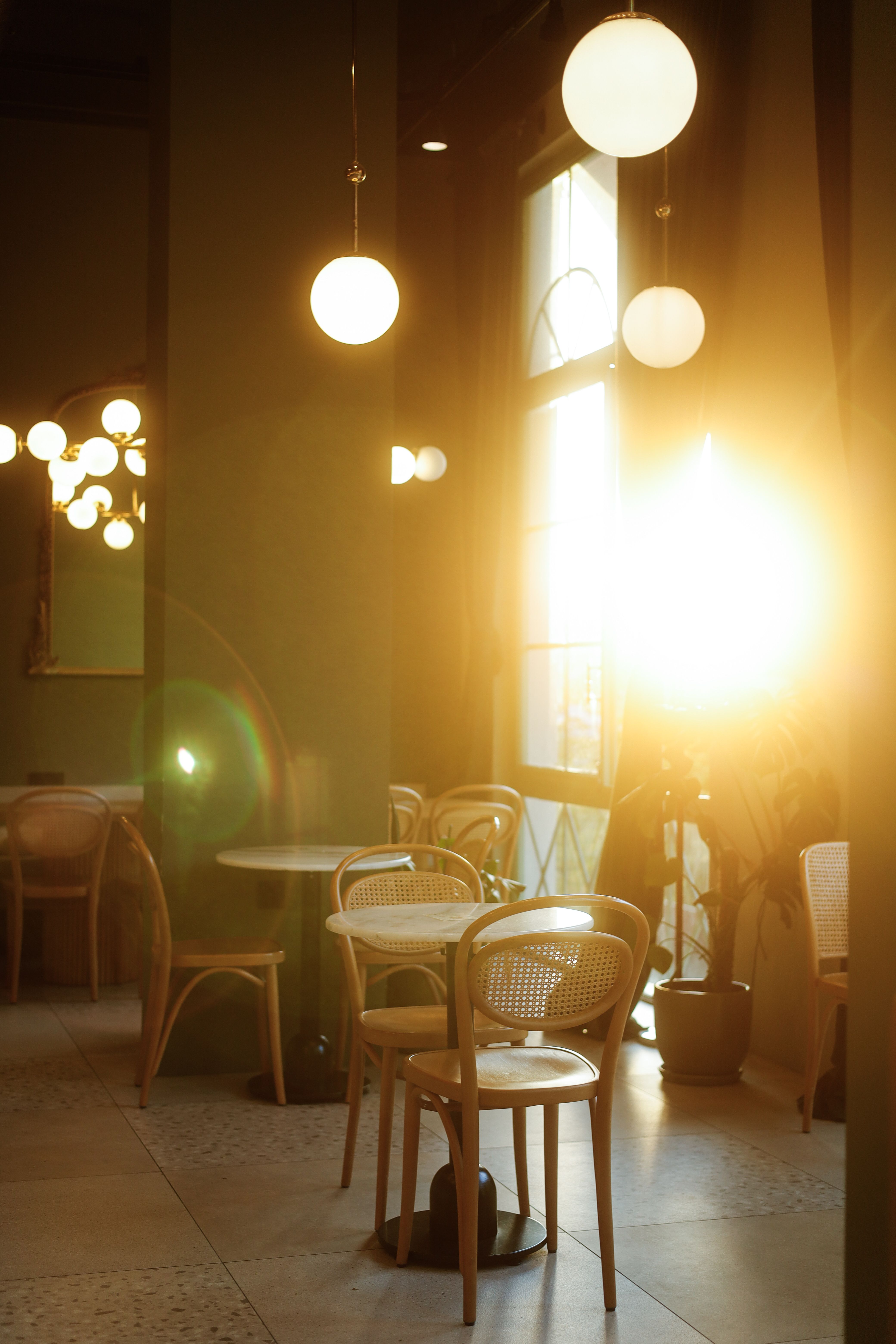 A sun shines through a window in a cafe · Free Stock Photo
